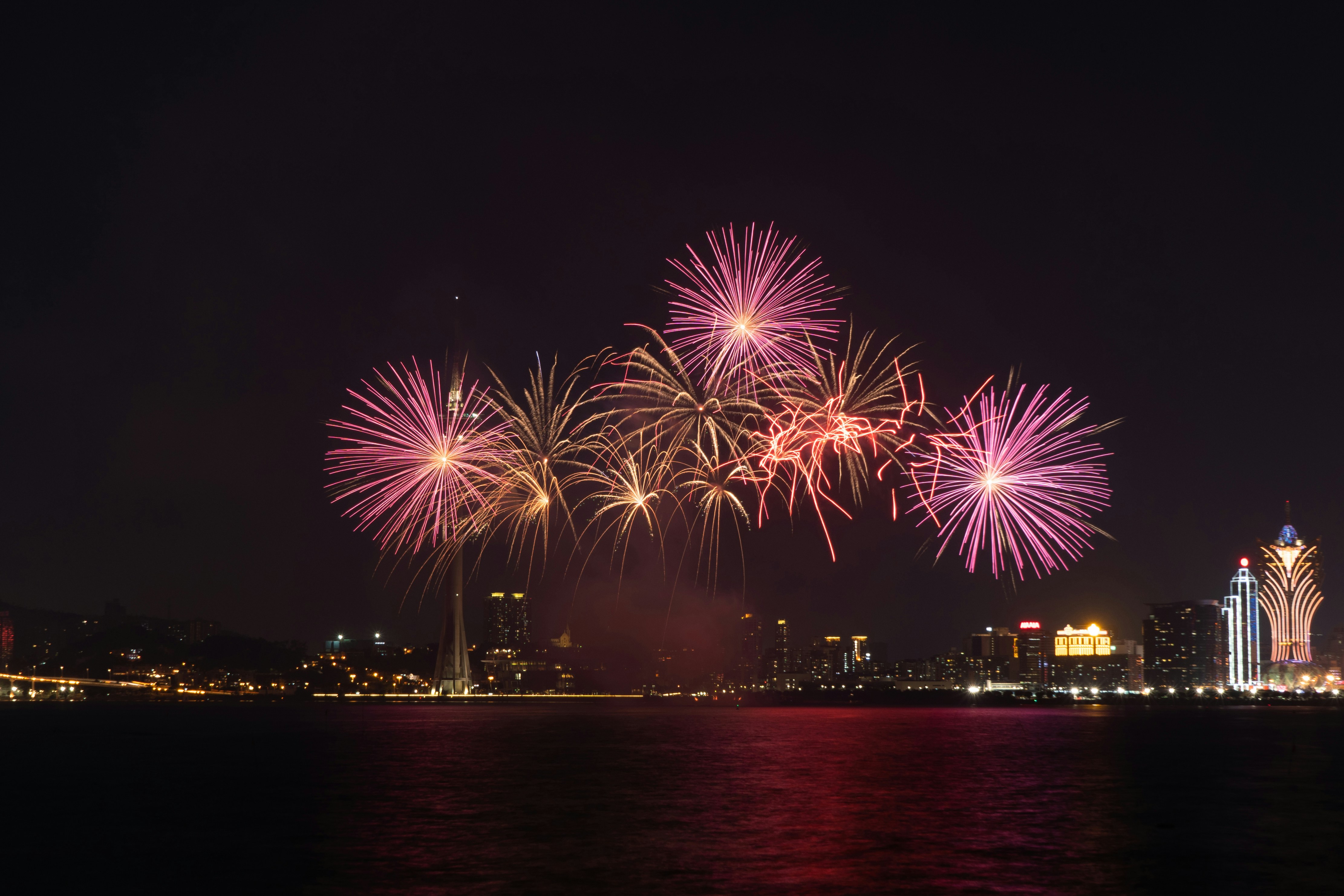 Fireworks display over city buildings during night time photo – Free ...