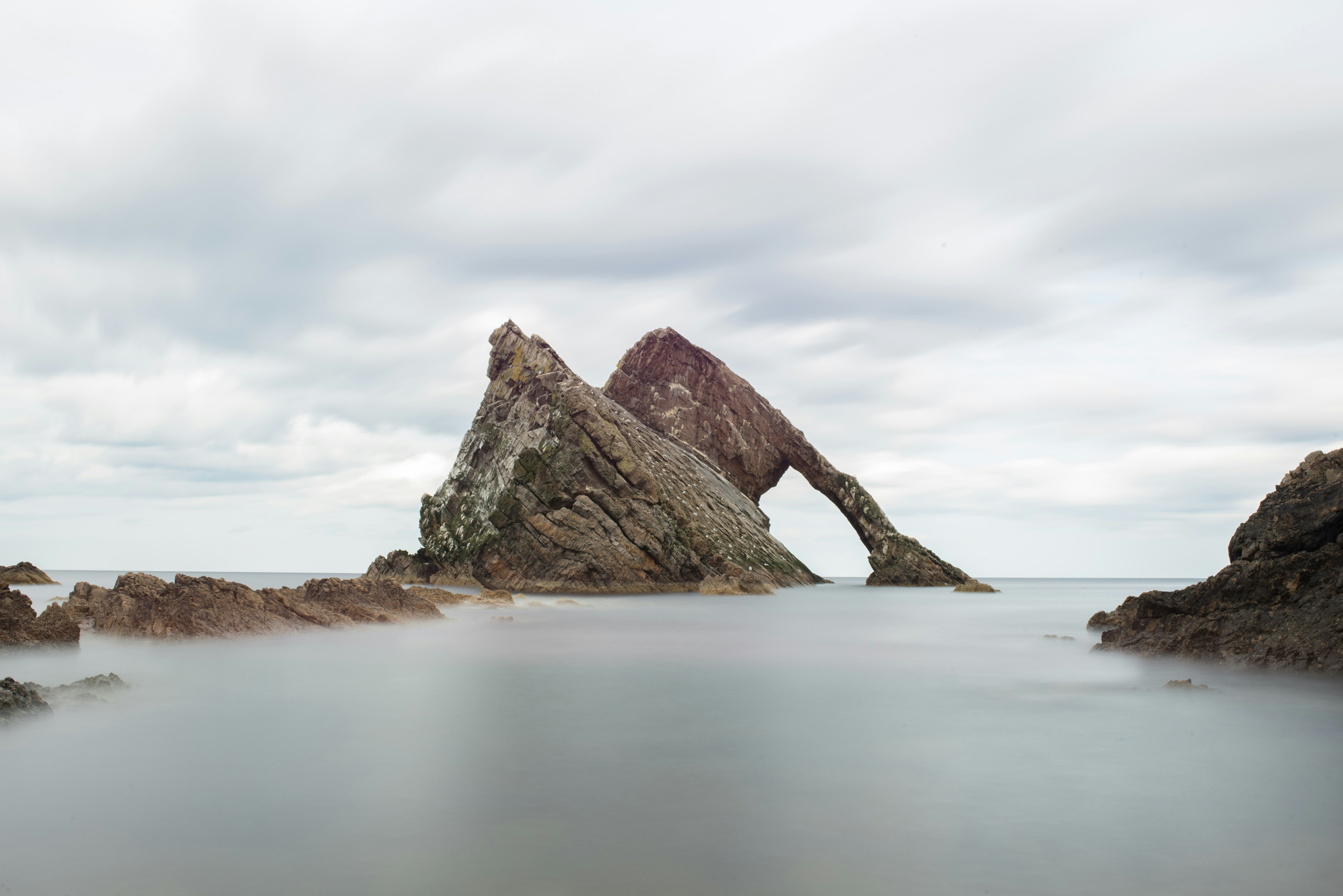 Isolated Arch: A Sea-Worged Rock Gate Near Calm Waters
