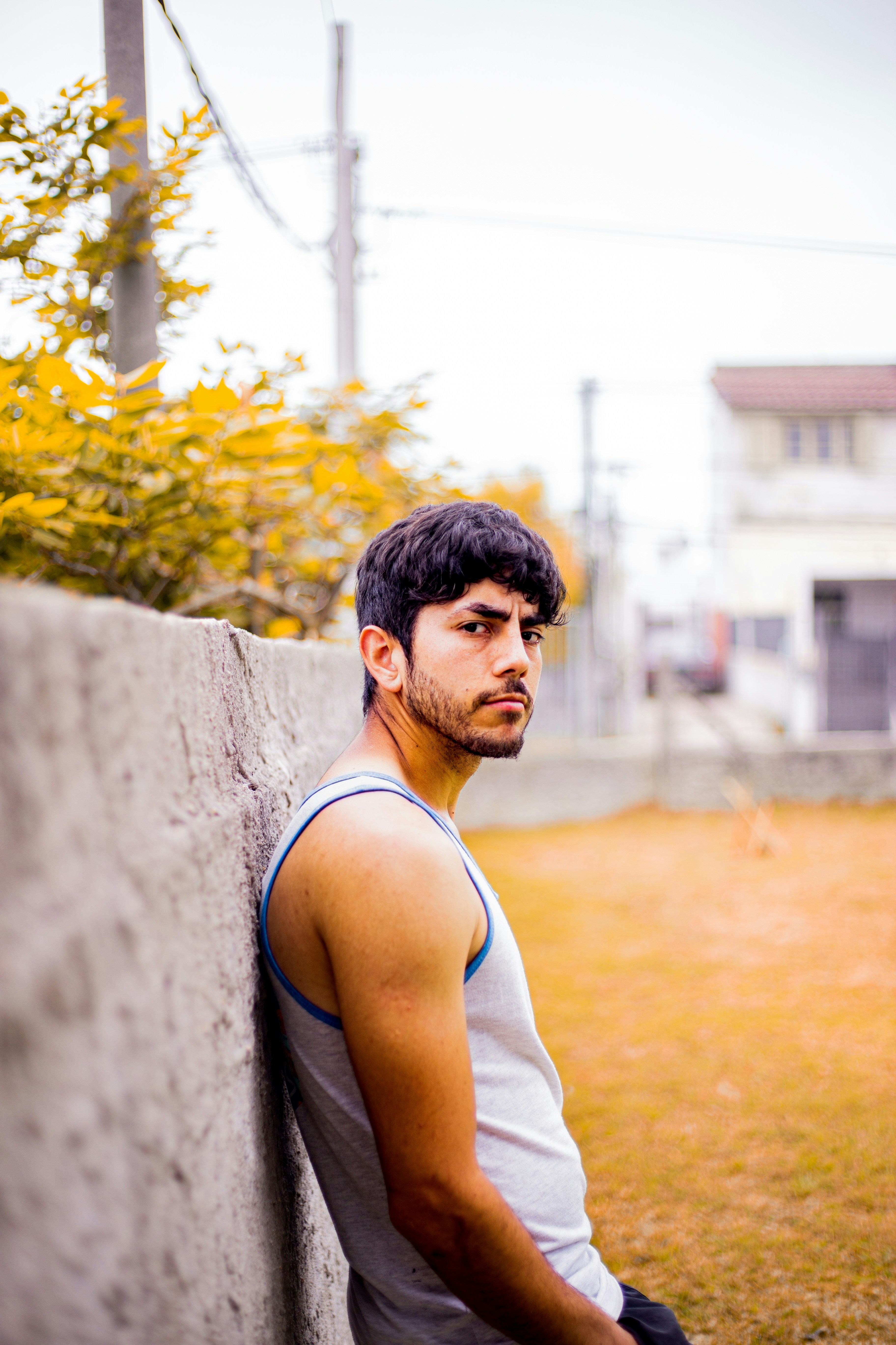 Lean Against the Wall: Quiet Confidence in Autumnal Street Light
