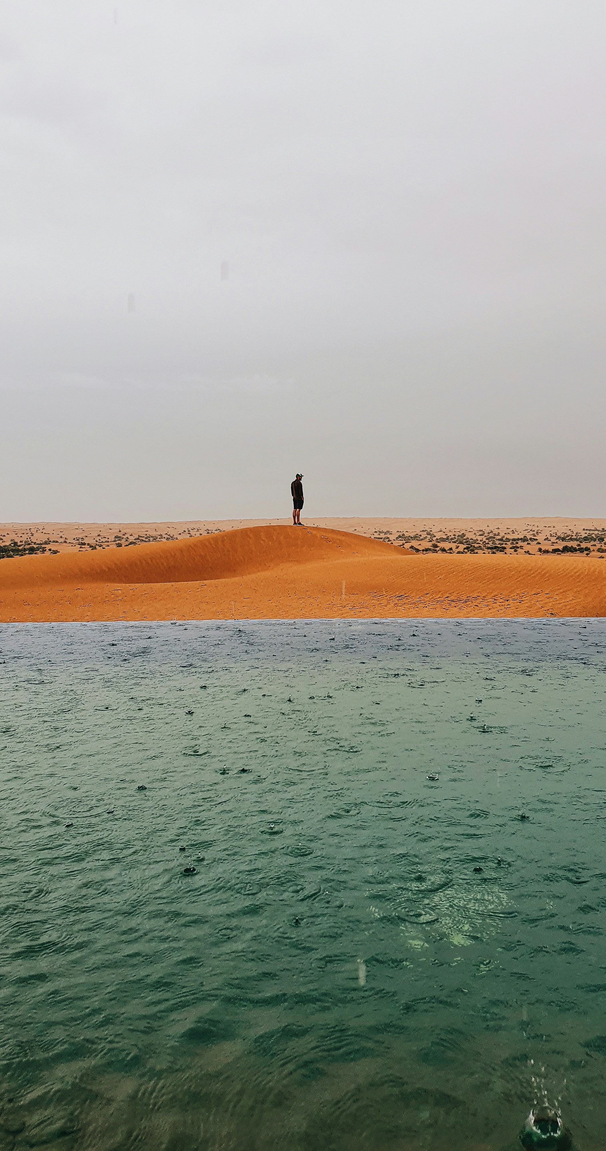 person standing on brown sand near body of water during daytimeDaniel Zacatenco