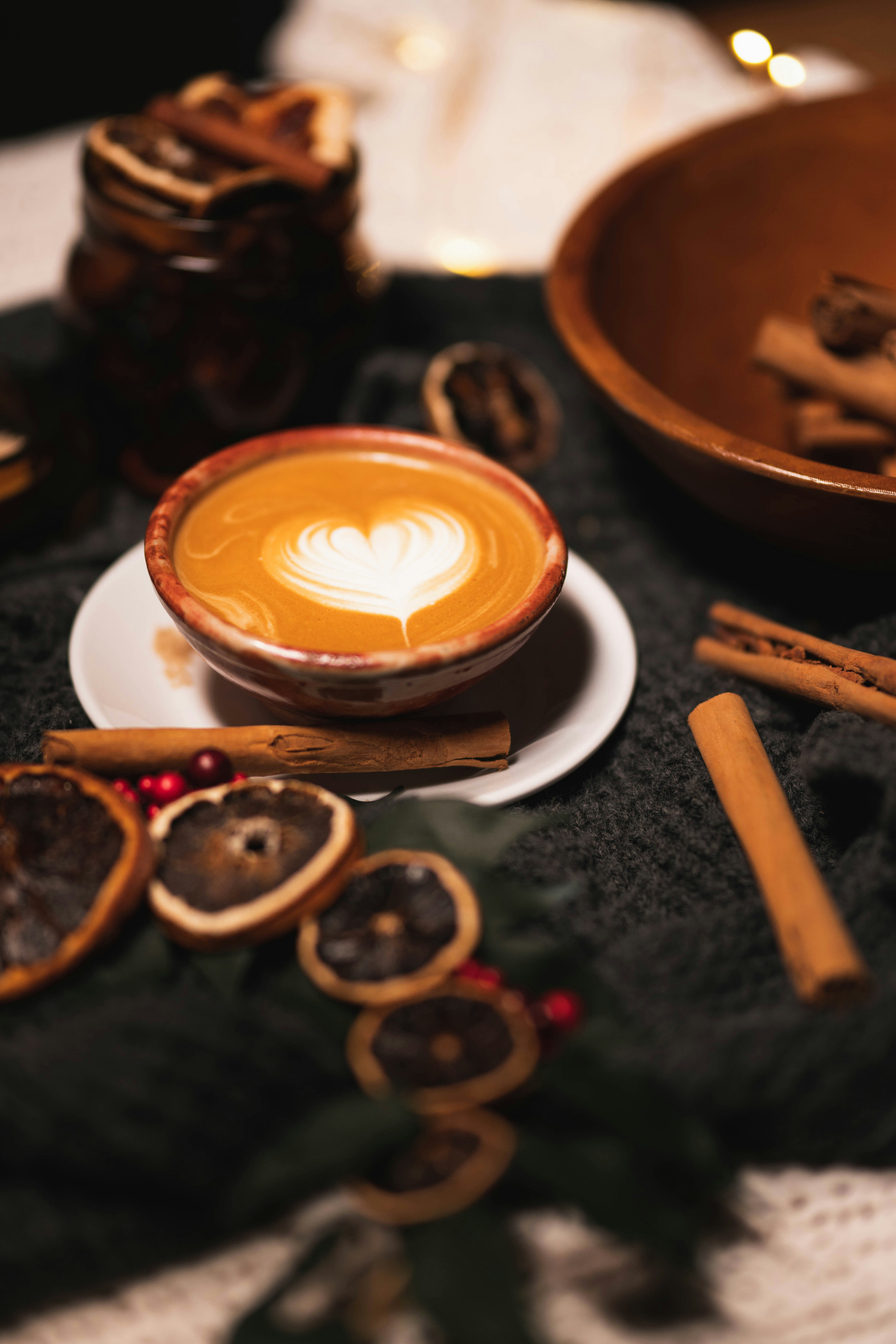 white ceramic cup with saucer beside brown wooden chopsticks