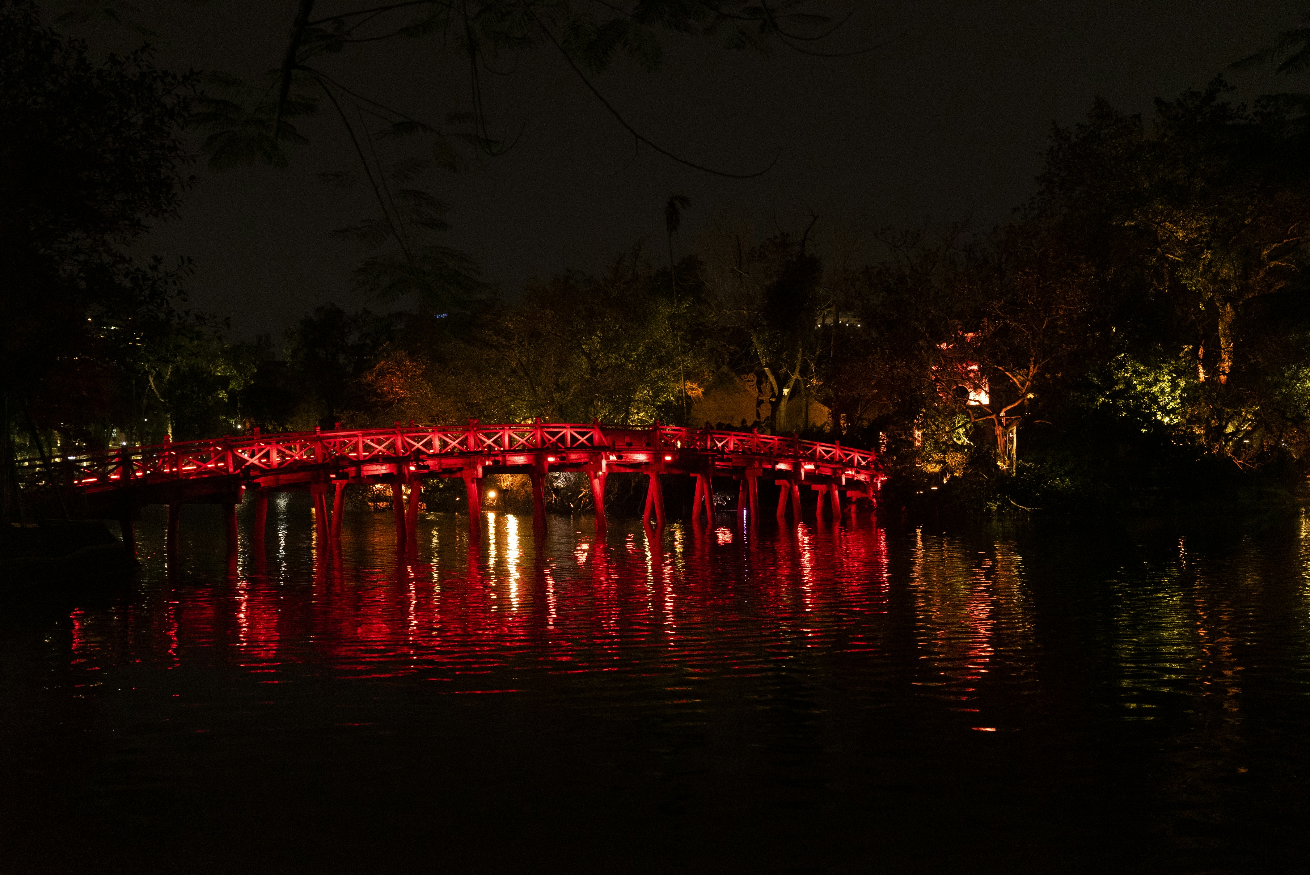 red lights on body of water during night time
