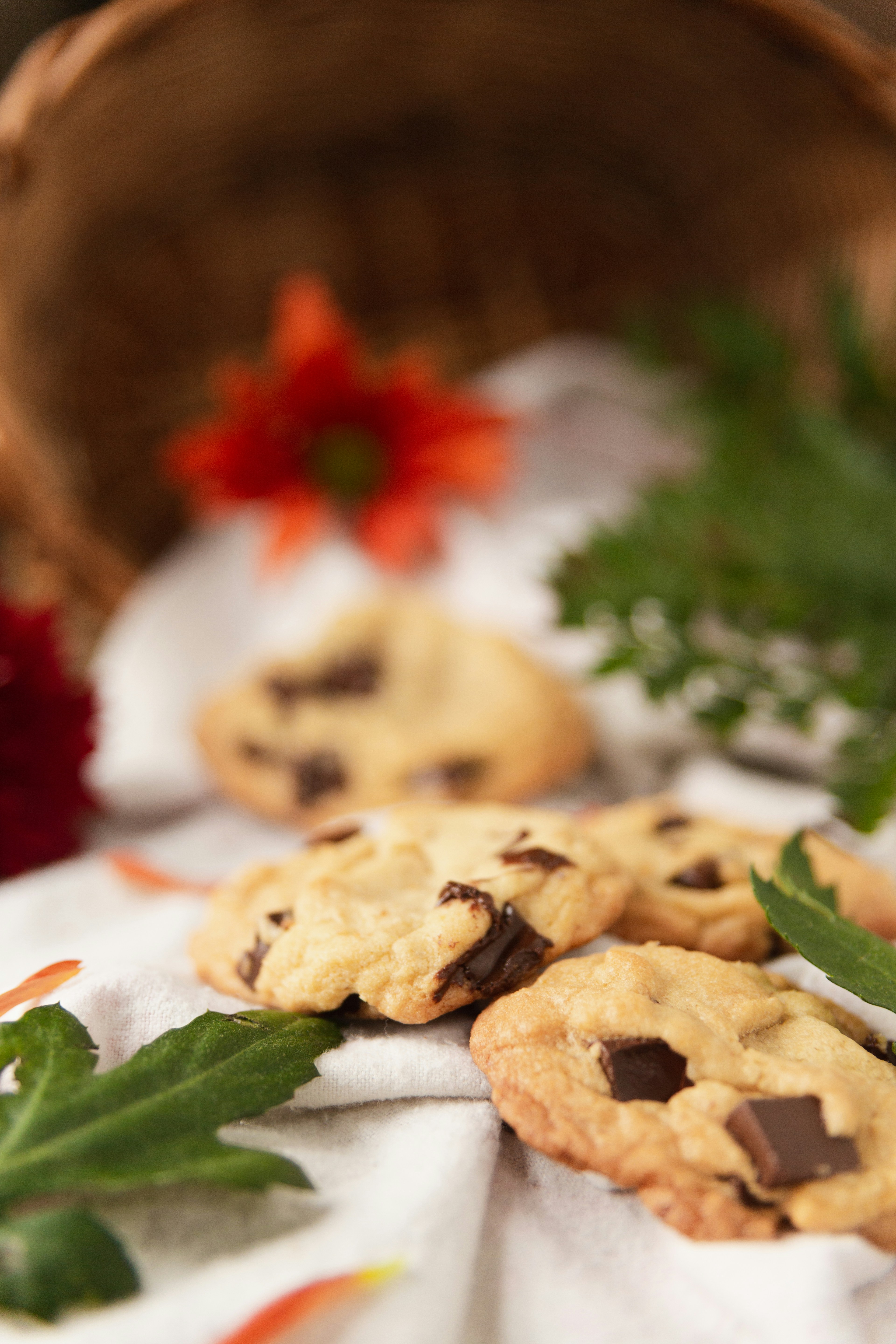 Autumn Still Life: Chocolate-Chip Cookies on Linen with a Wicker Backdrop