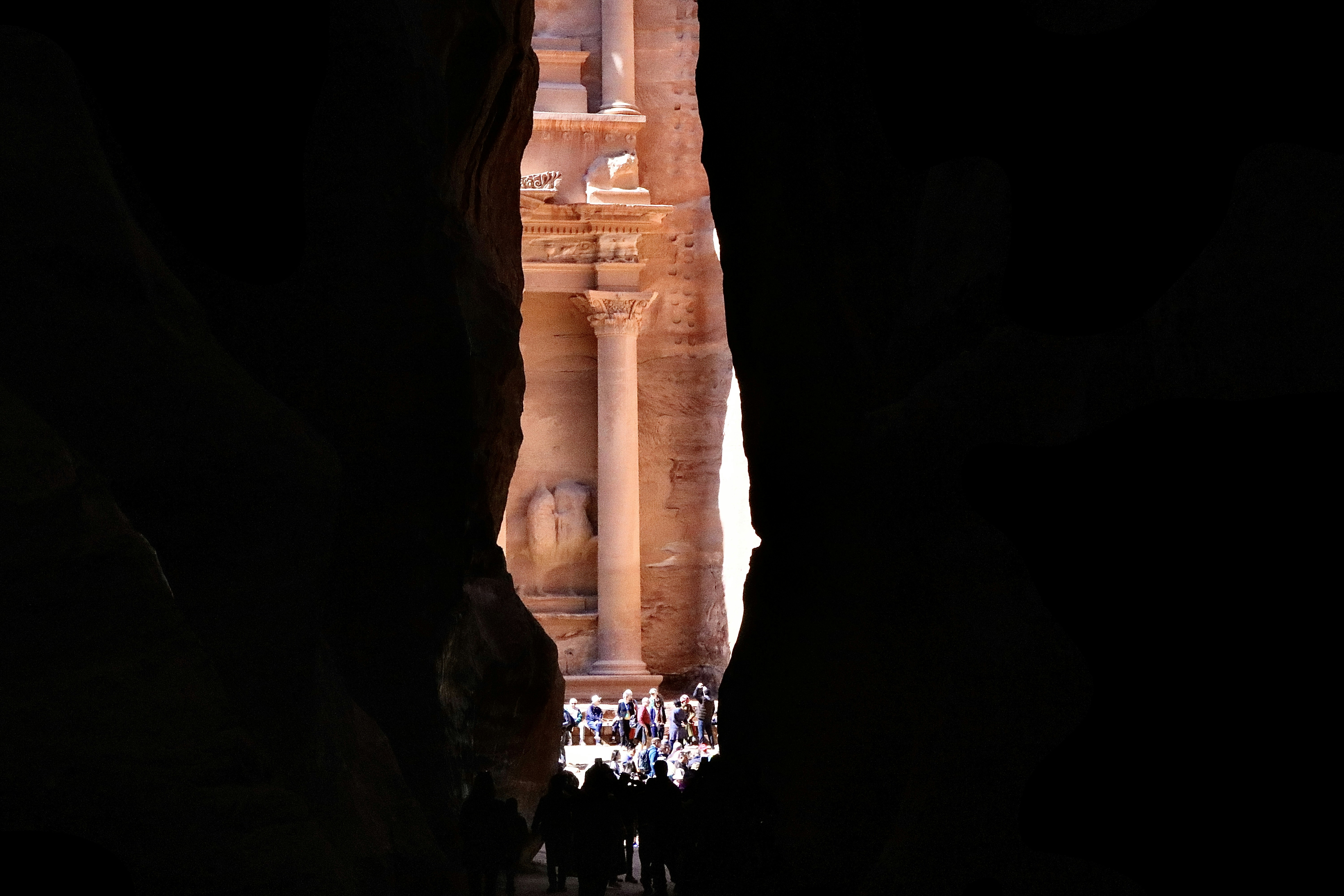 View of Petra's iconic sandstone columns framed by shadowy canyon walls.