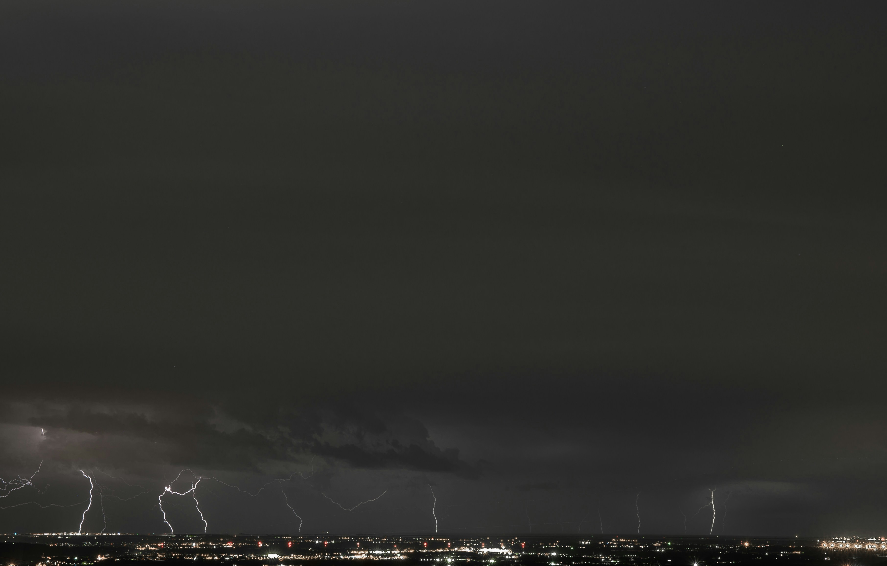 Forked Lightning Over a Sleeping City Horizon