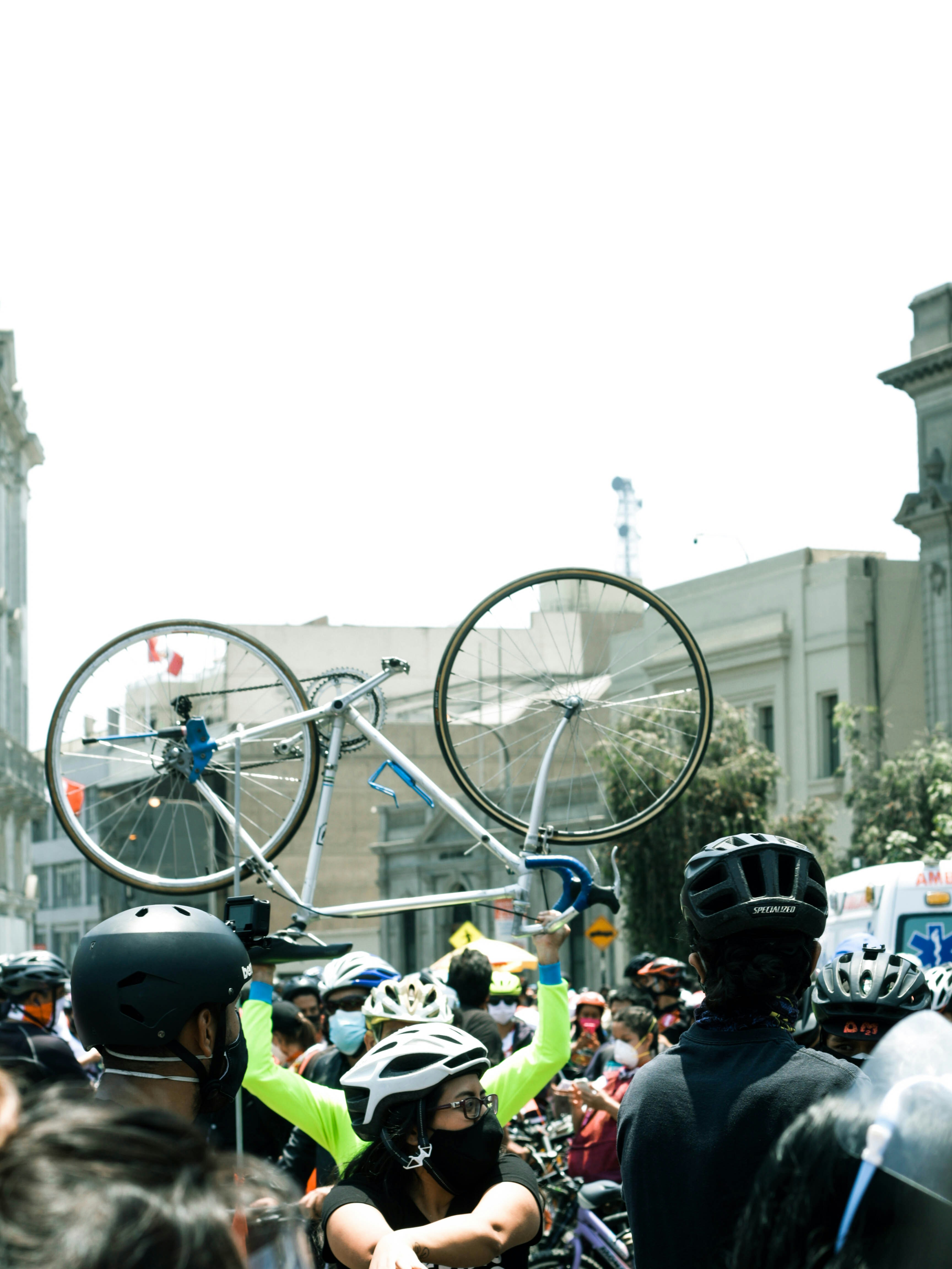 Cyclist Lift: A Vertical City Parade of Bikes Above the Crowd