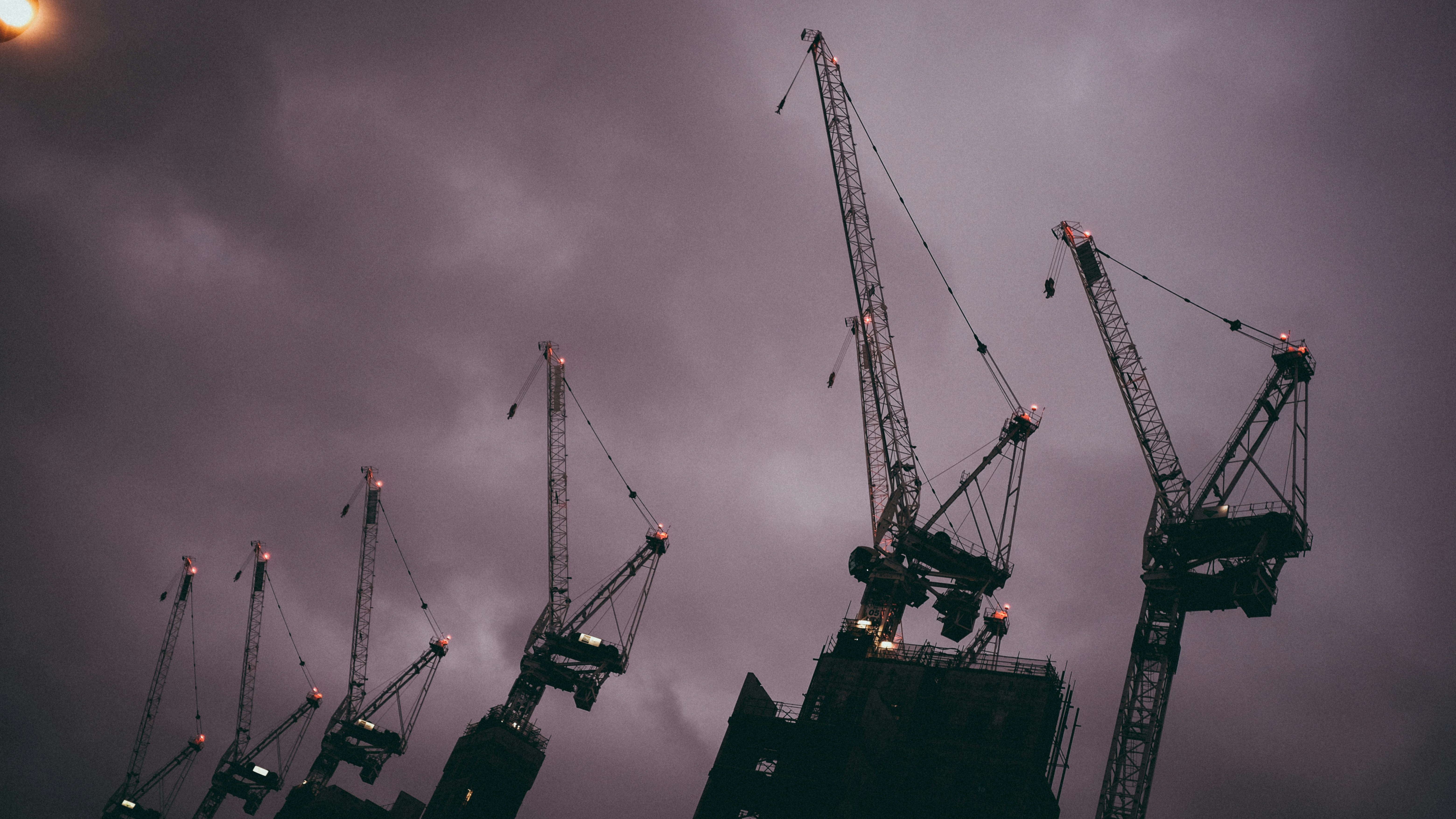 Twilight Cranes over a Moody Industrial Horizon