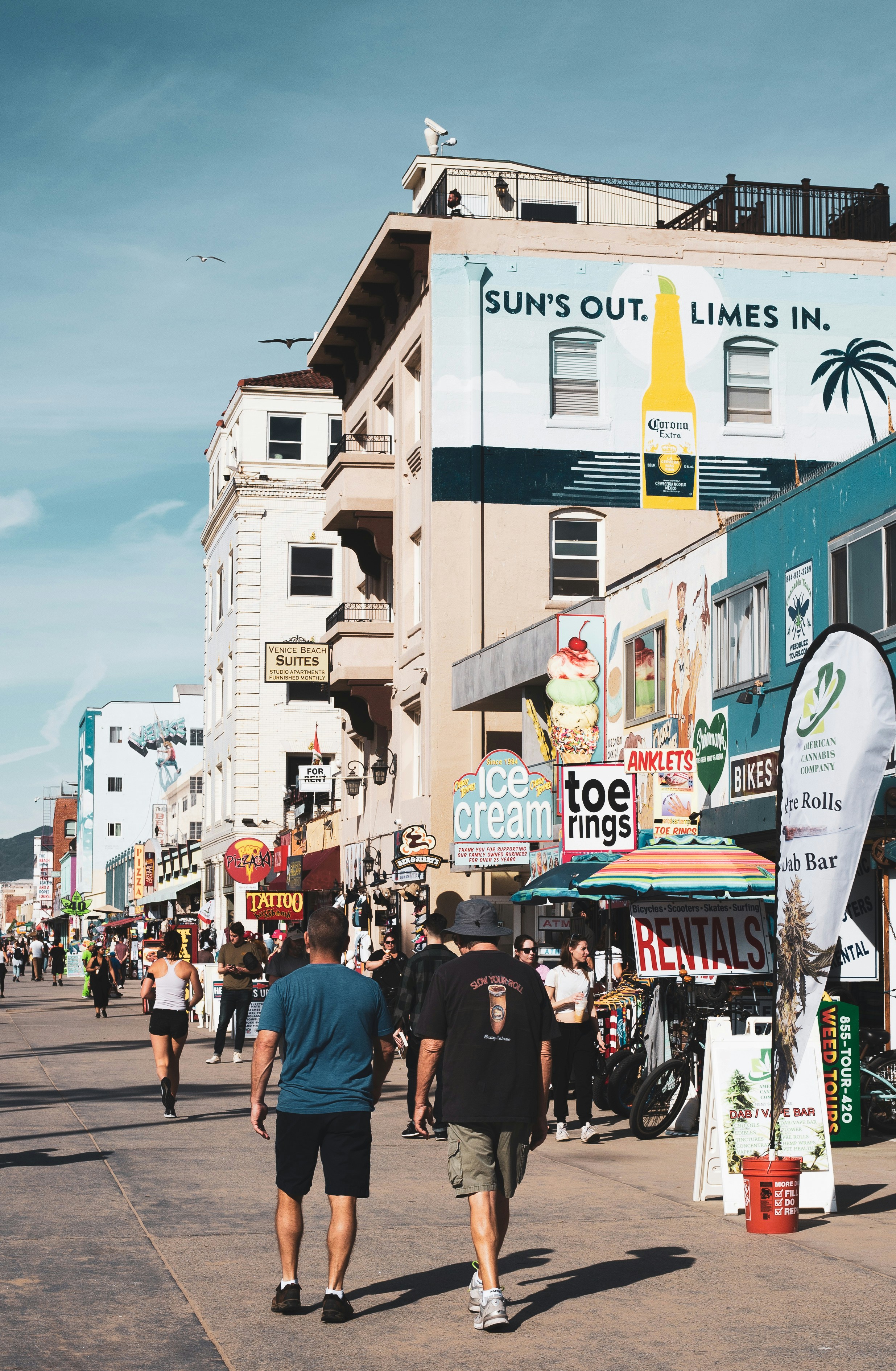 Sunlit Boardwalk Amid Neon Signs and Coastal Vibe