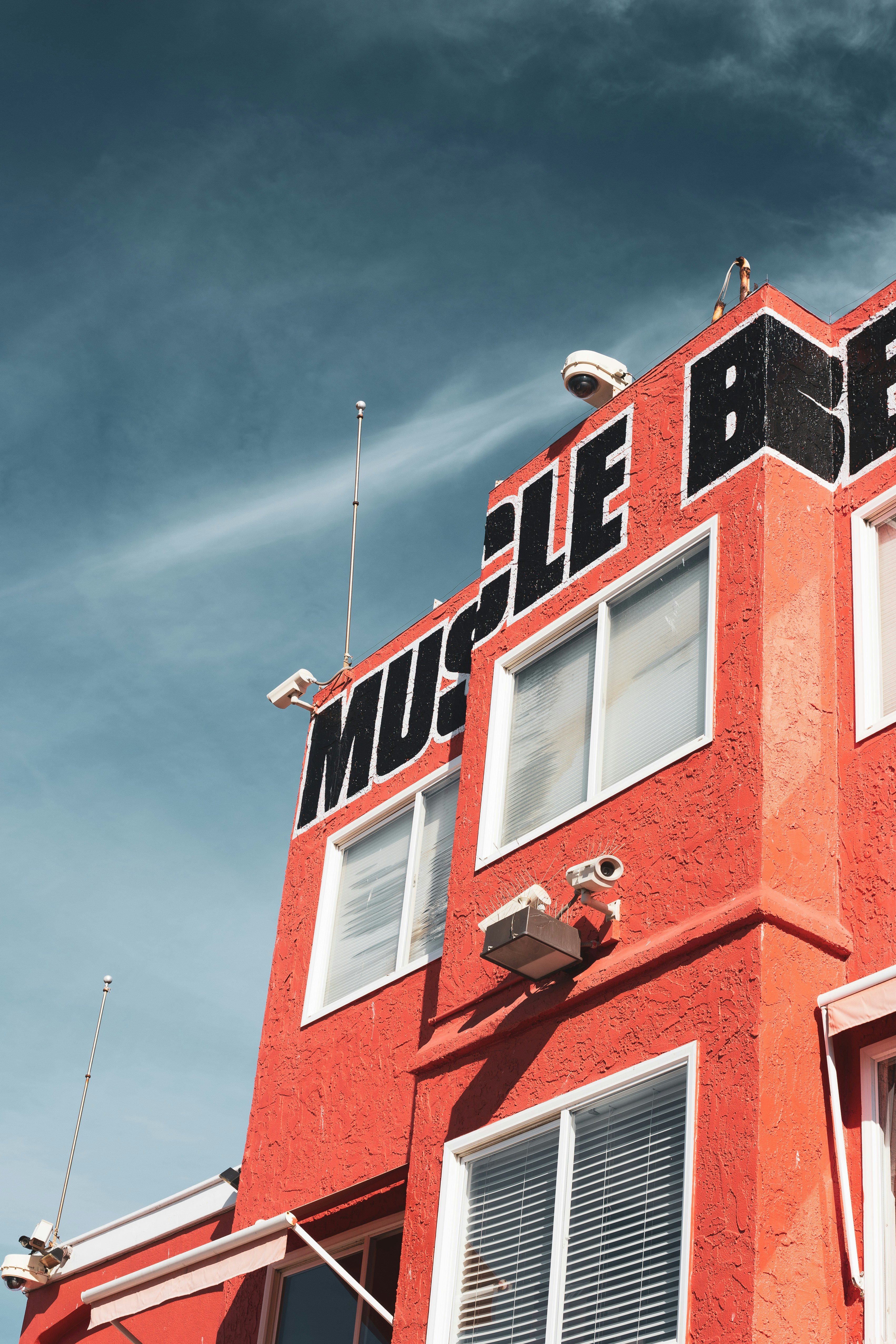 Red concrete building with white window frame photo – Free Venice Image ...