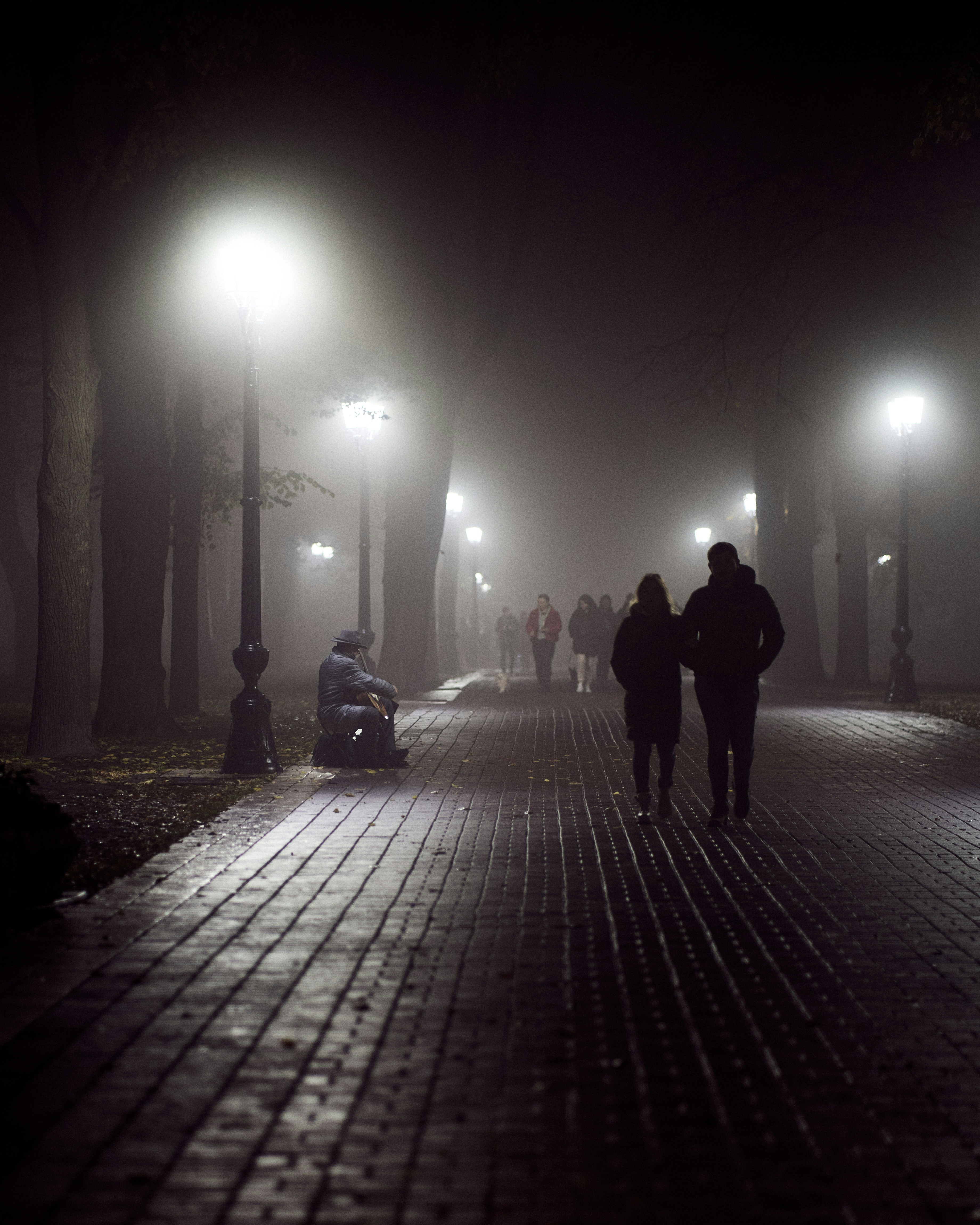 People Walking On Street At Night