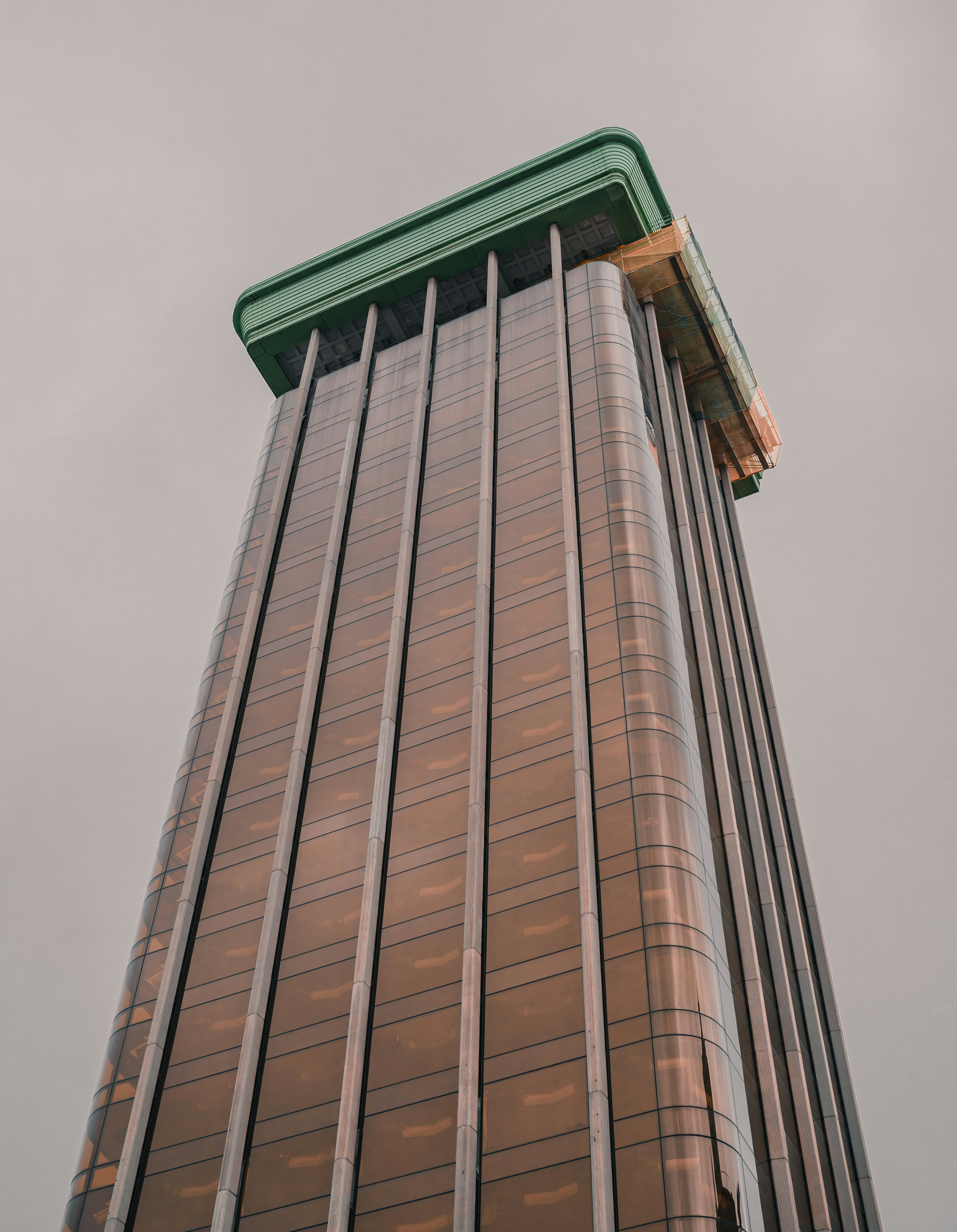 Green-Capped Glass Tower Leaning Toward the Sky