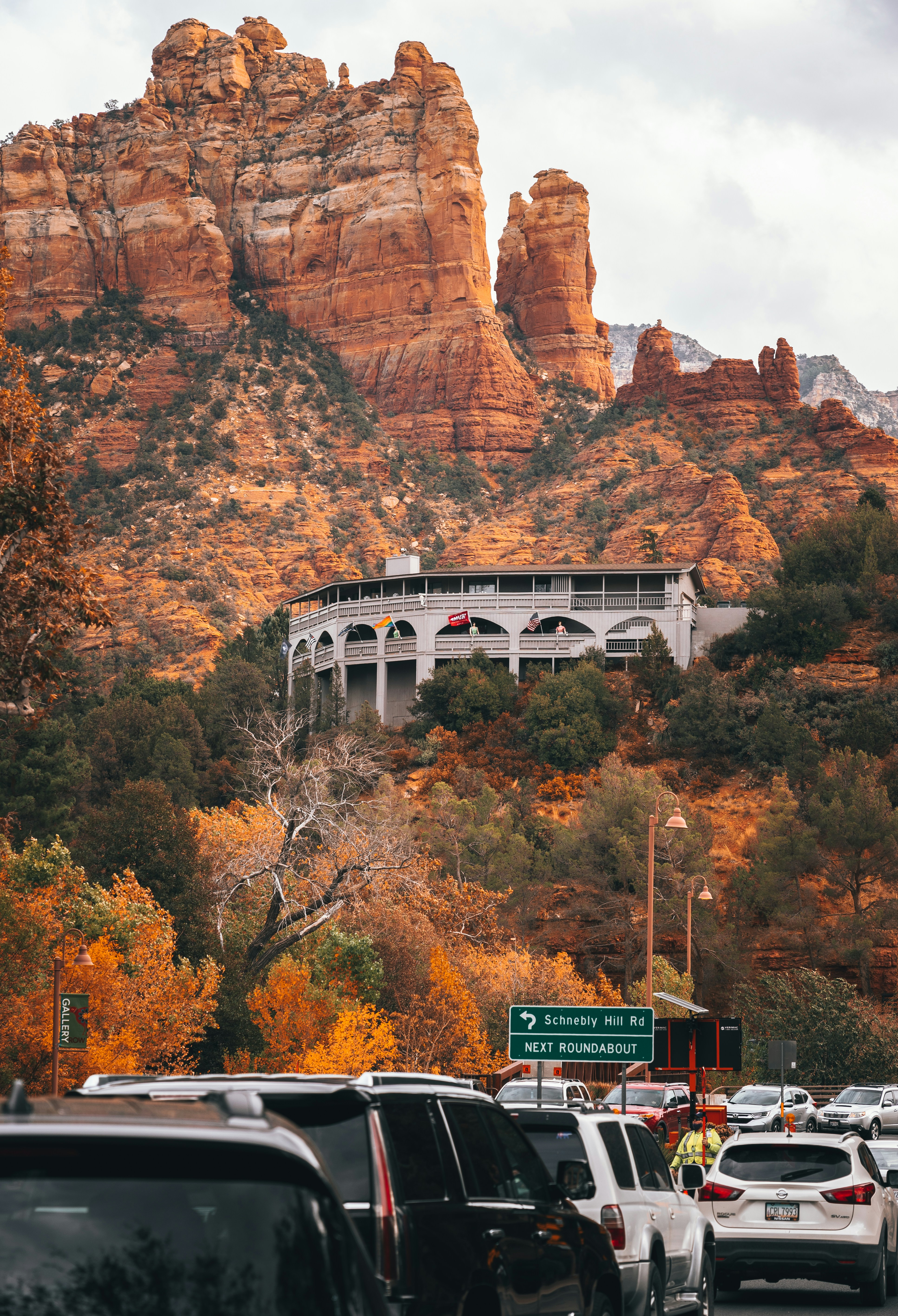 Autumn Cliff Scene: Riverside Lodge Rising Above Red Rock