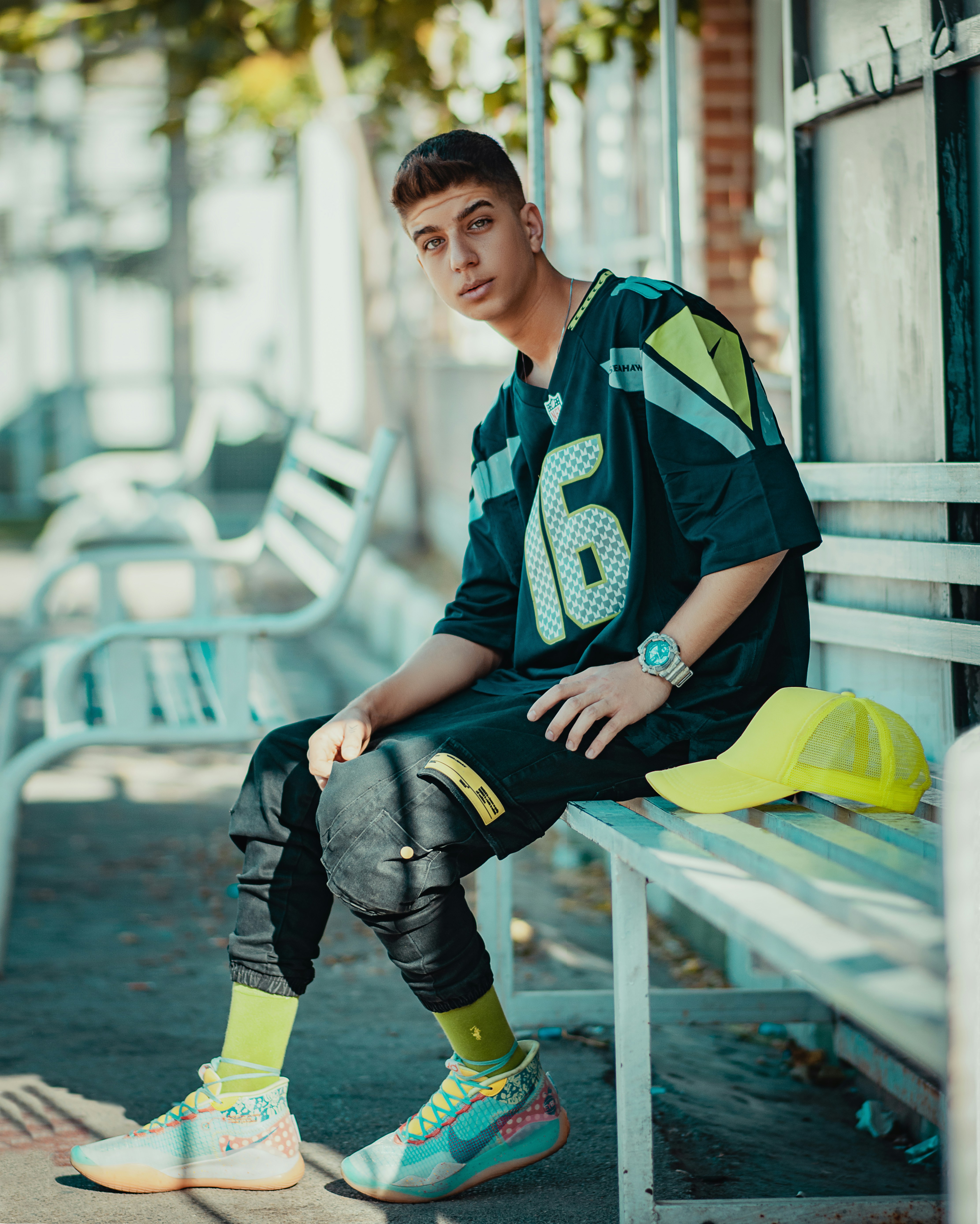Teal Jersey, Neon Sneakers: A Quiet Urban Portrait on a Sunlit Bench