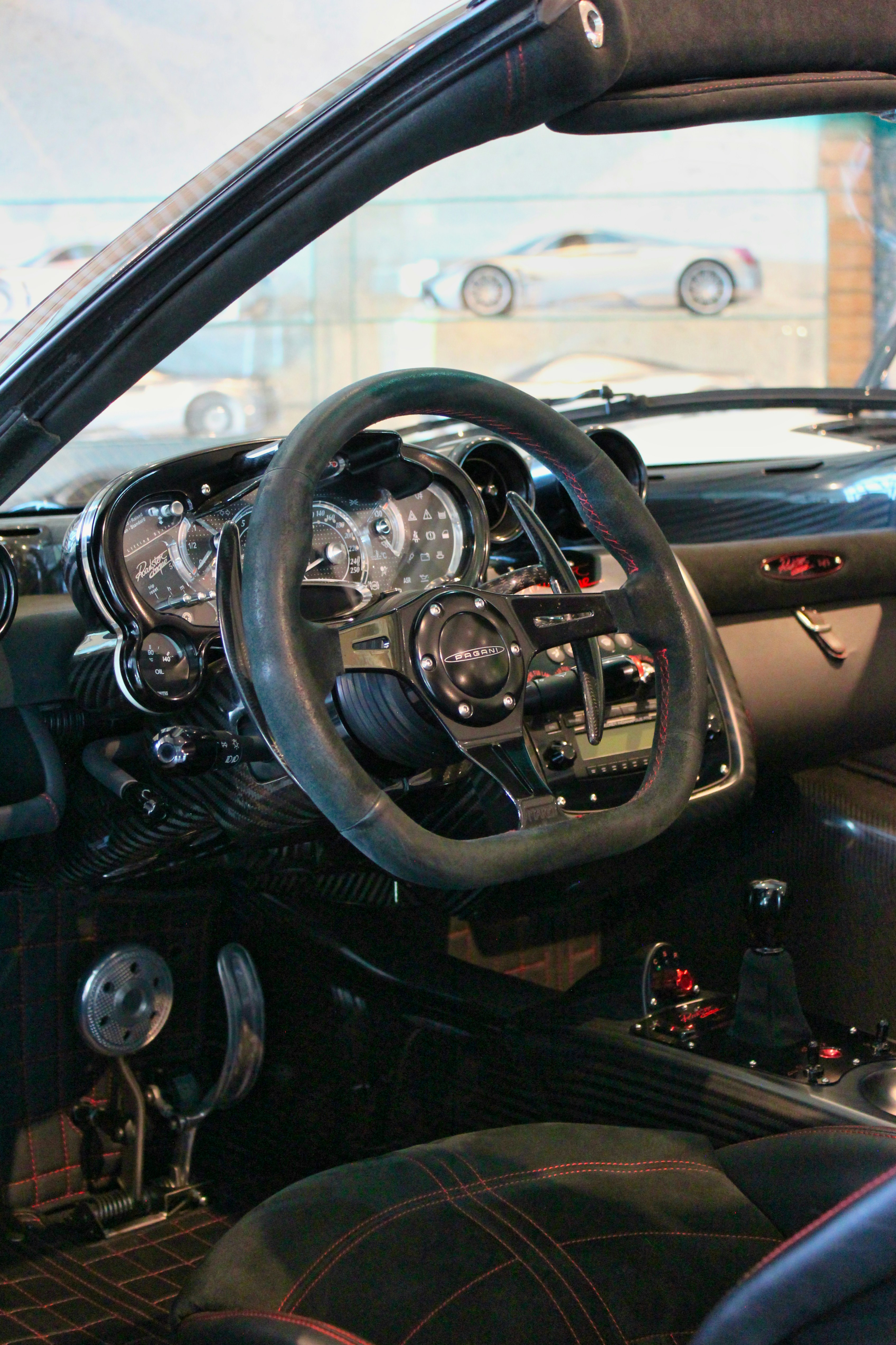 black car steering wheel during daytime