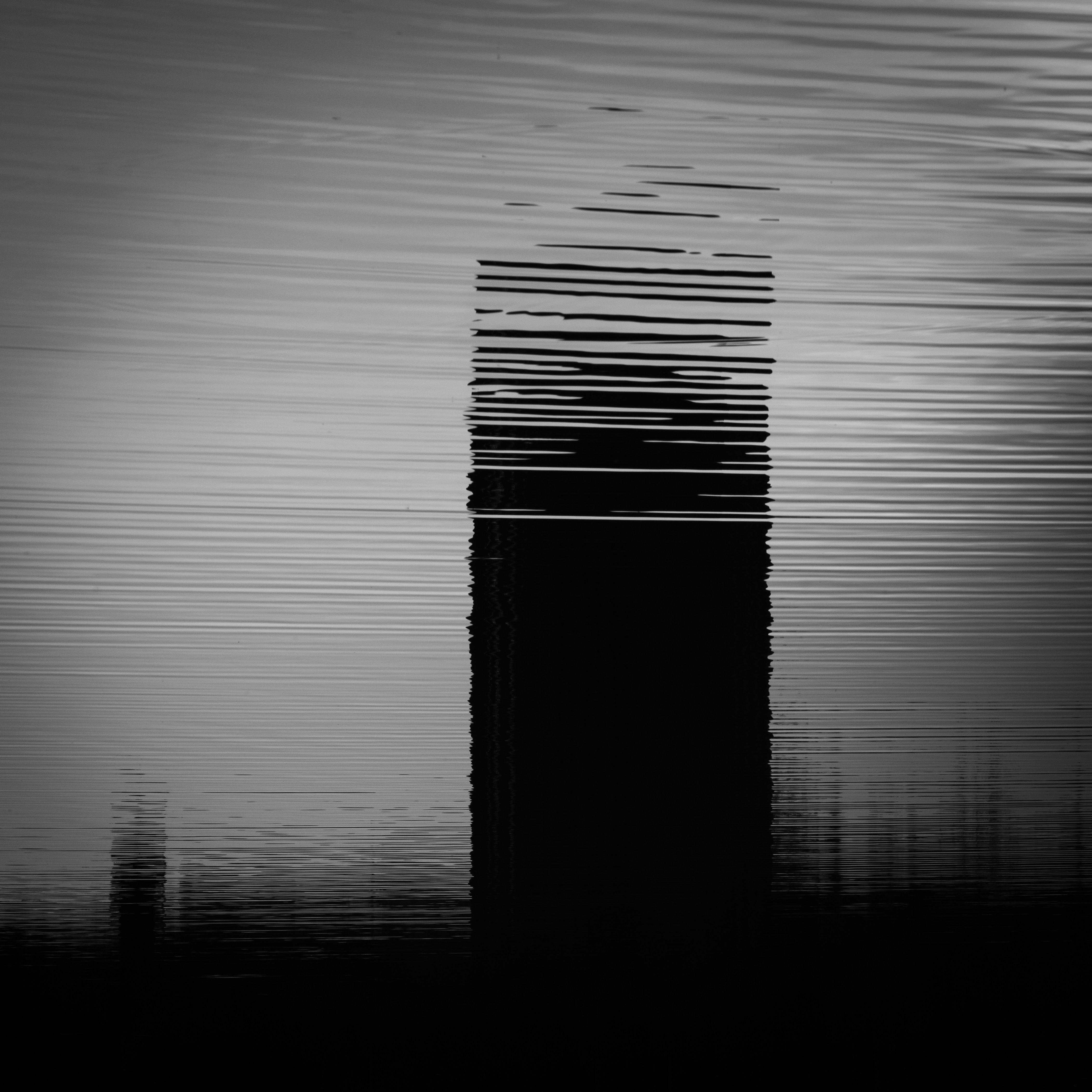 Monochrome Pier: Refracted Boldness Across Quiet Water