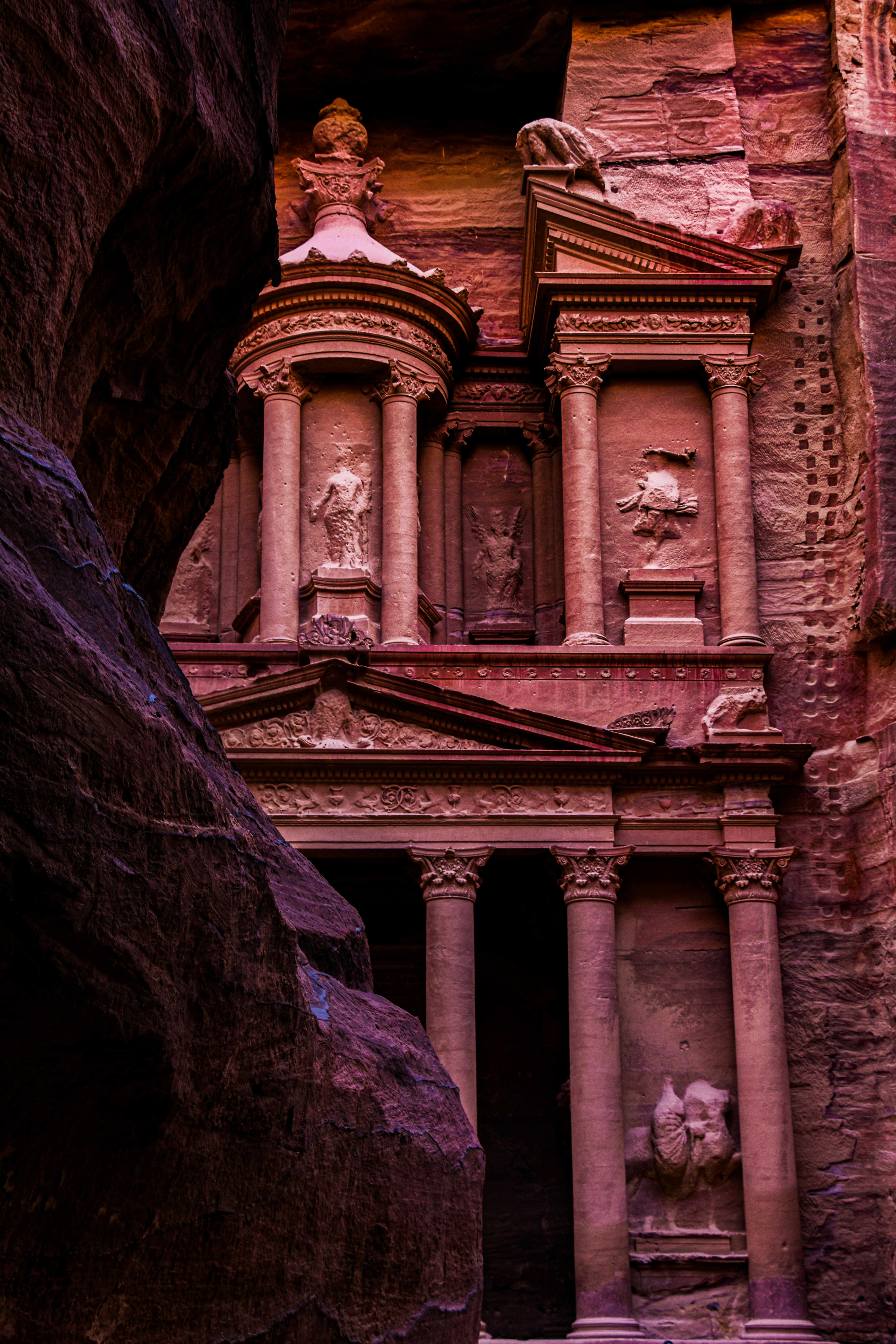 Petra's Canyon Facade: A Red Rock Treasury Framed by Shadowed Gorge