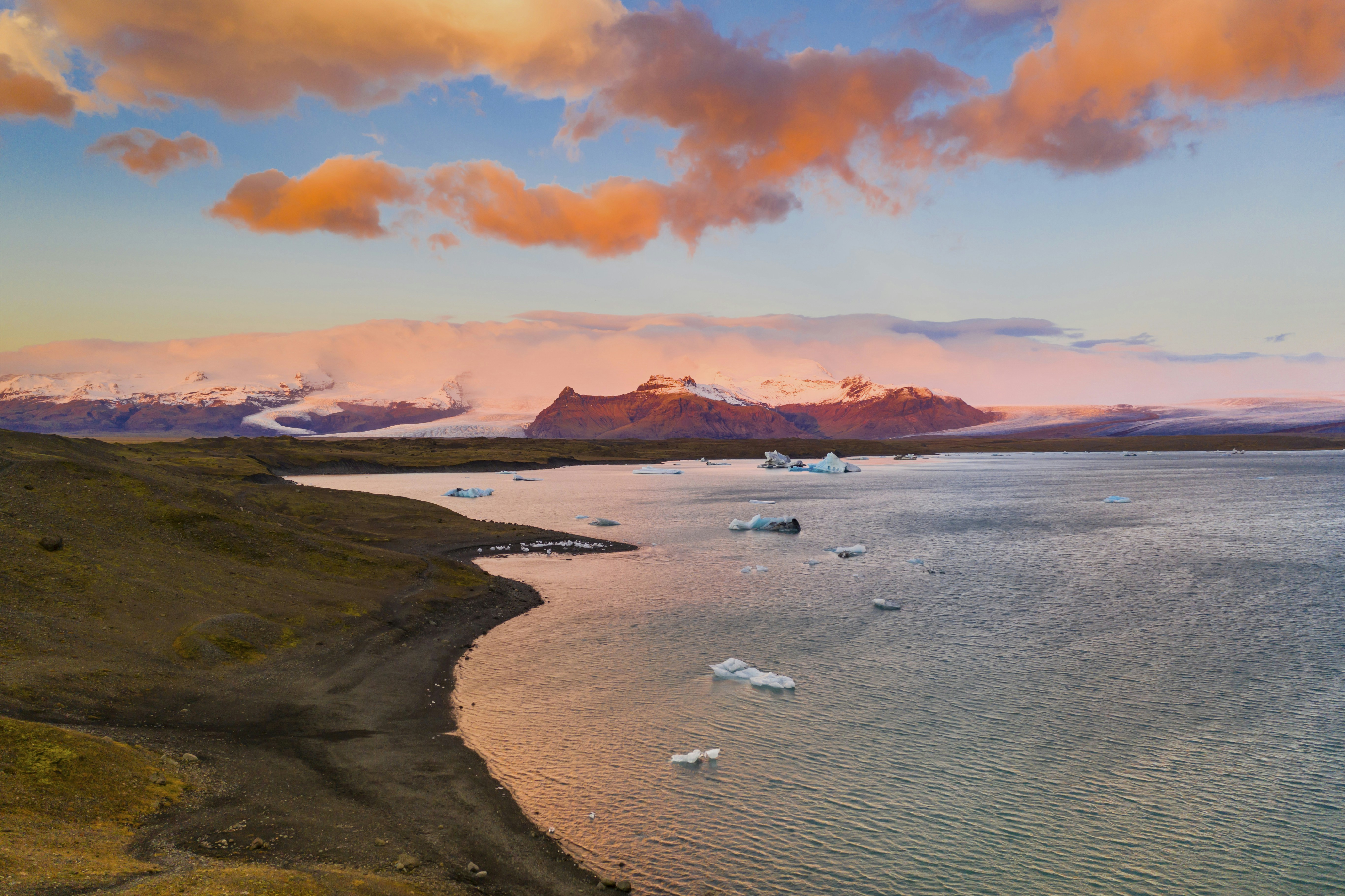 Pastel Fjord at Dusk: Icebergs Drift Along a Quiet Shore