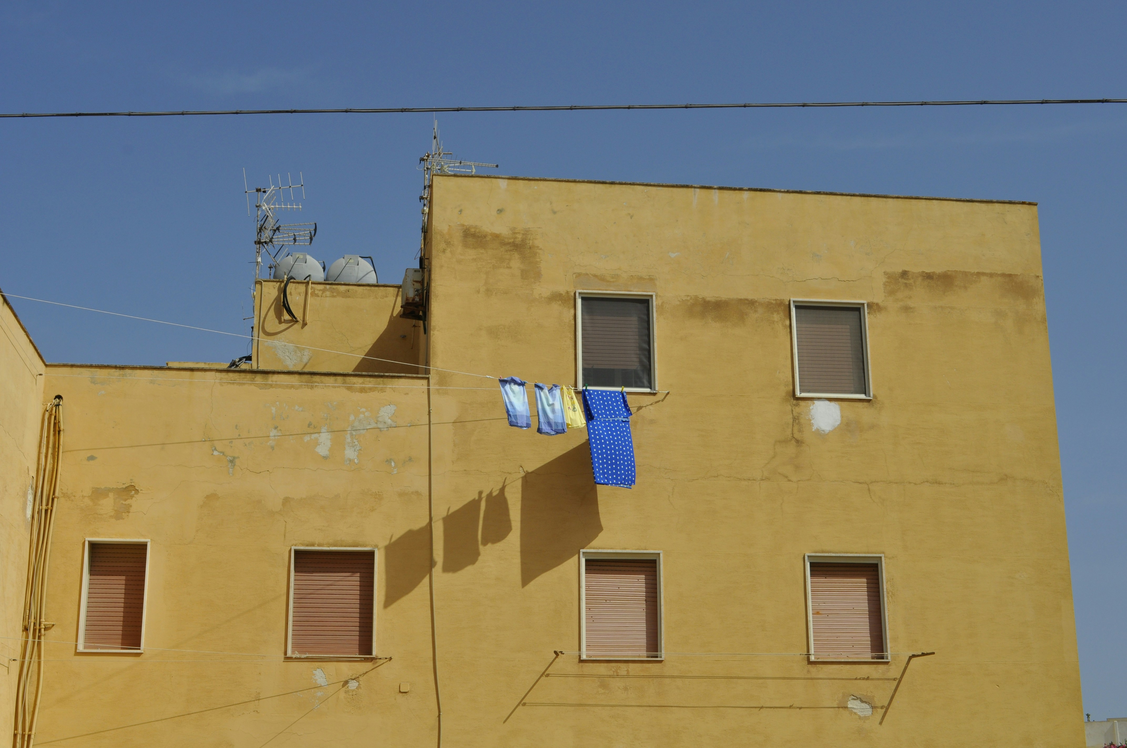 Old house with washing line on a hot day in Favignana Italy Sicily