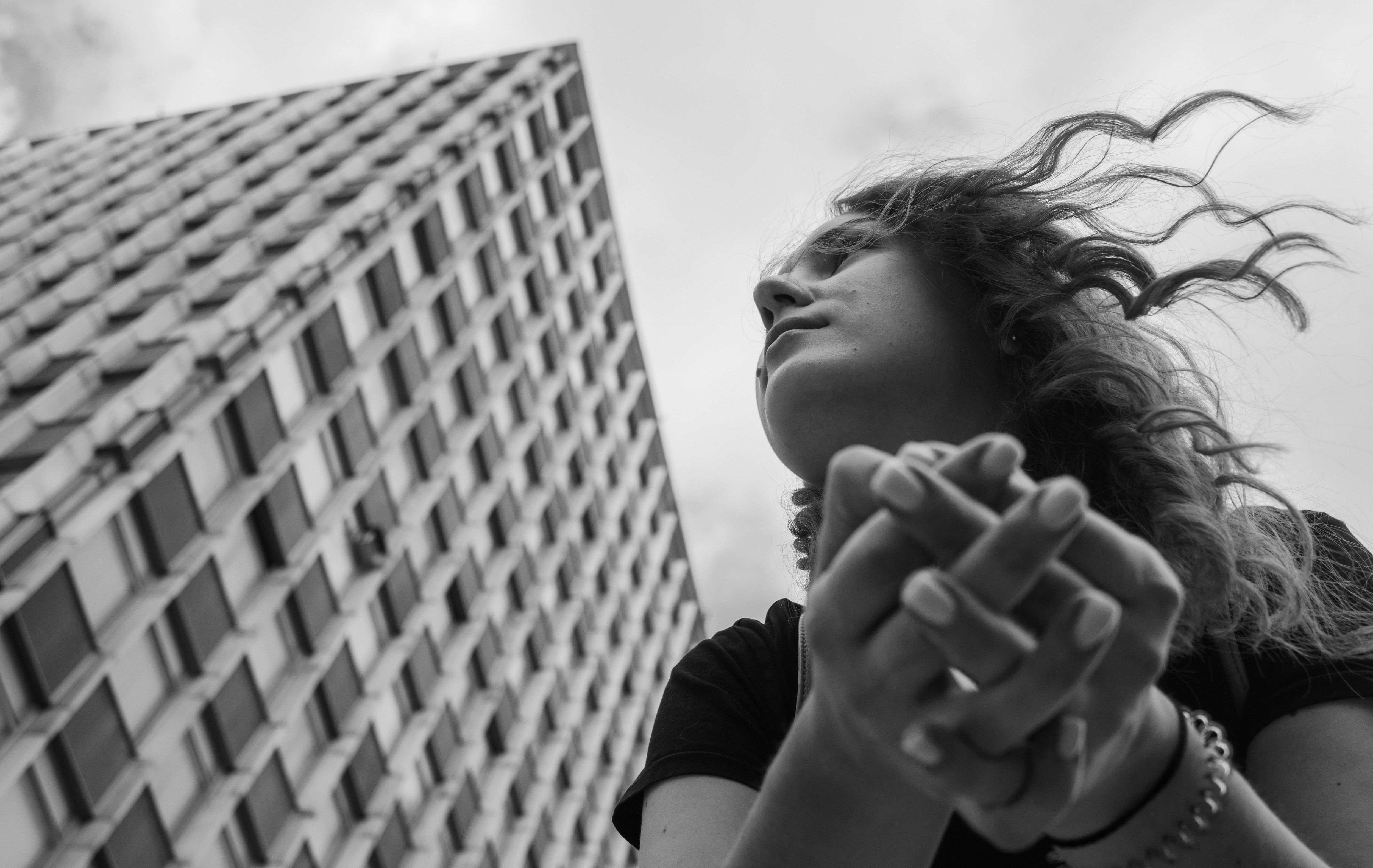 Rising Hands, City Edge: A Portrait in Ultrawide Shadows