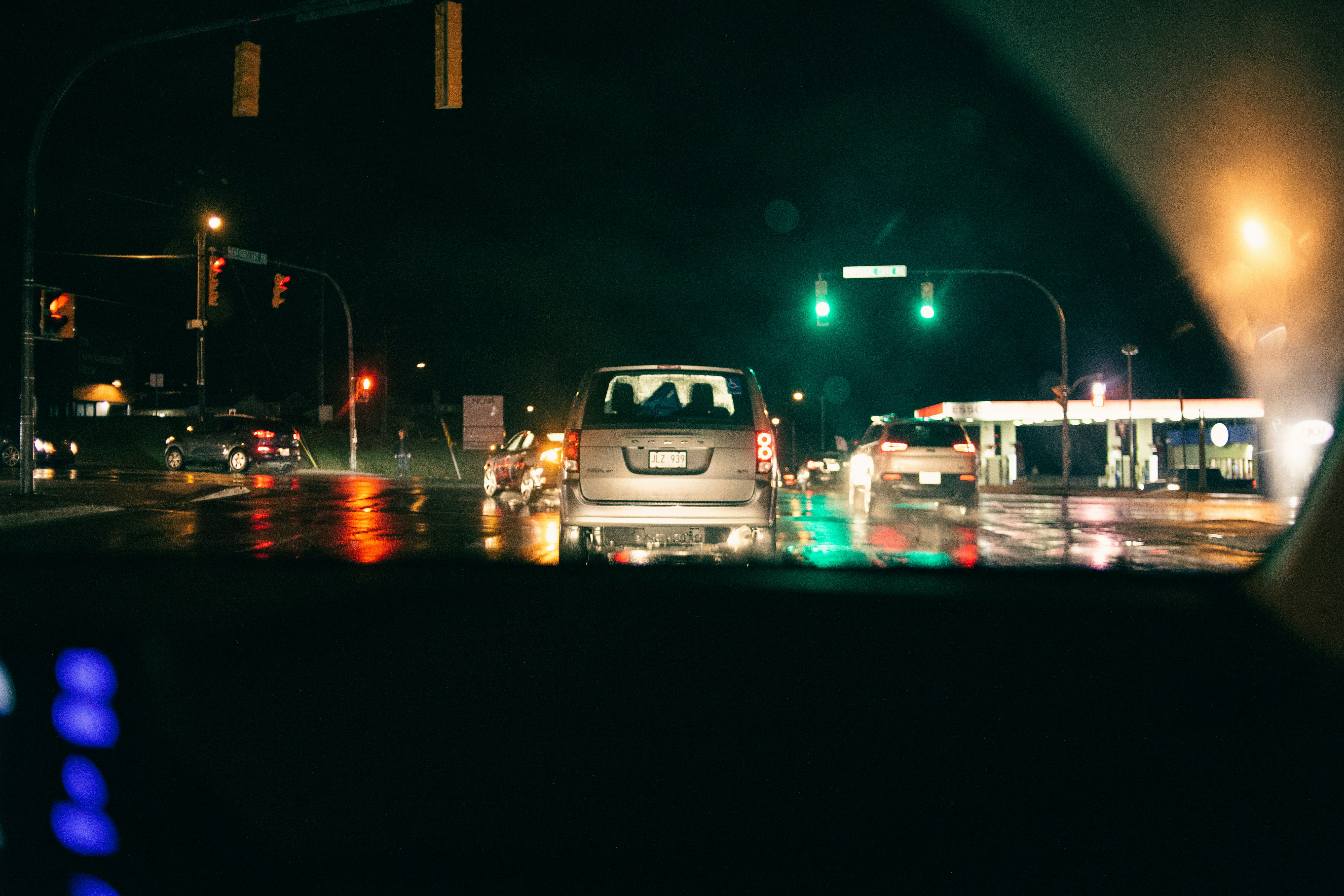 Neon Reflections at Night: A Driver's View Toward the Green Light