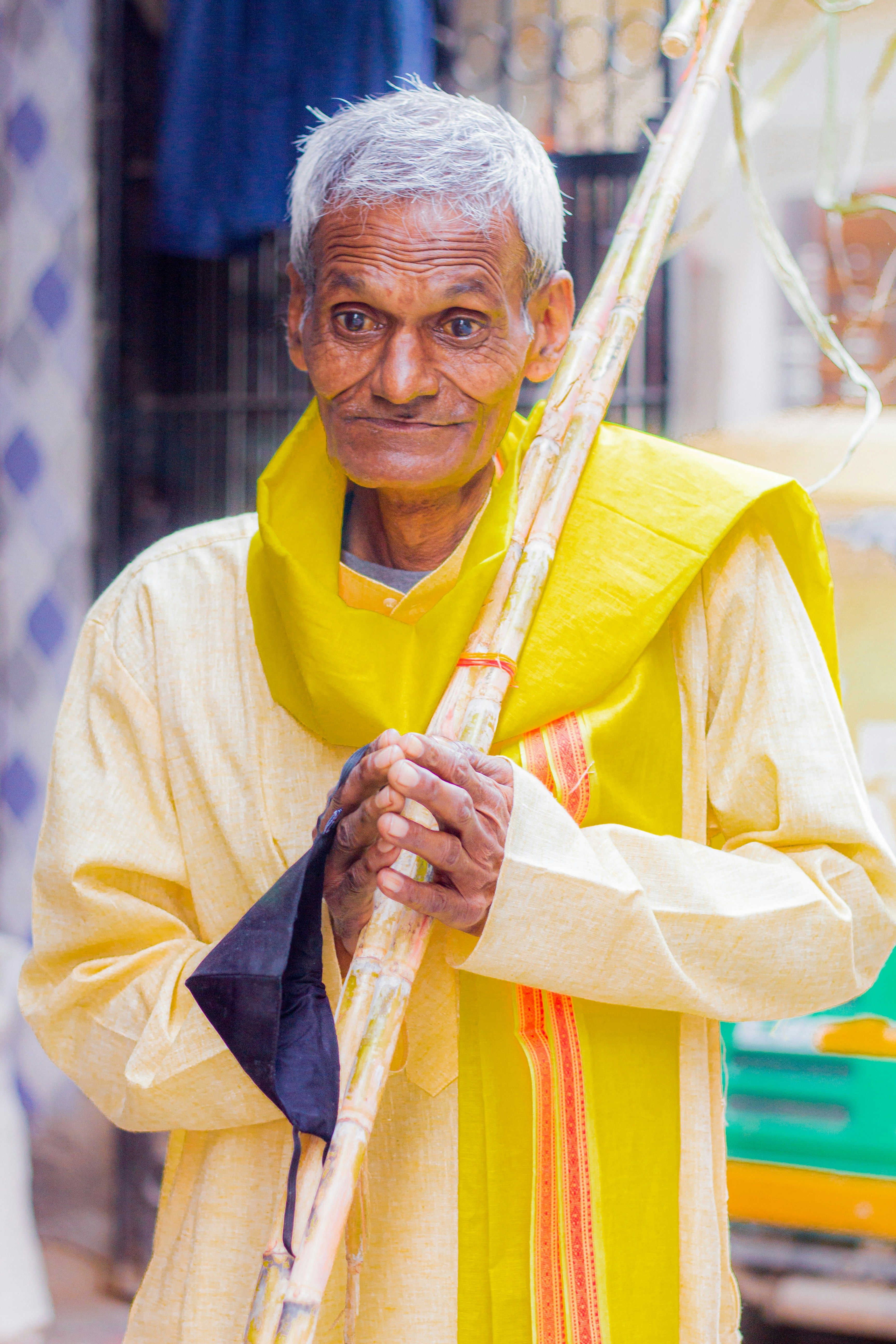 Man in yellow robe holding stick photo – Free Human Image on Unsplash