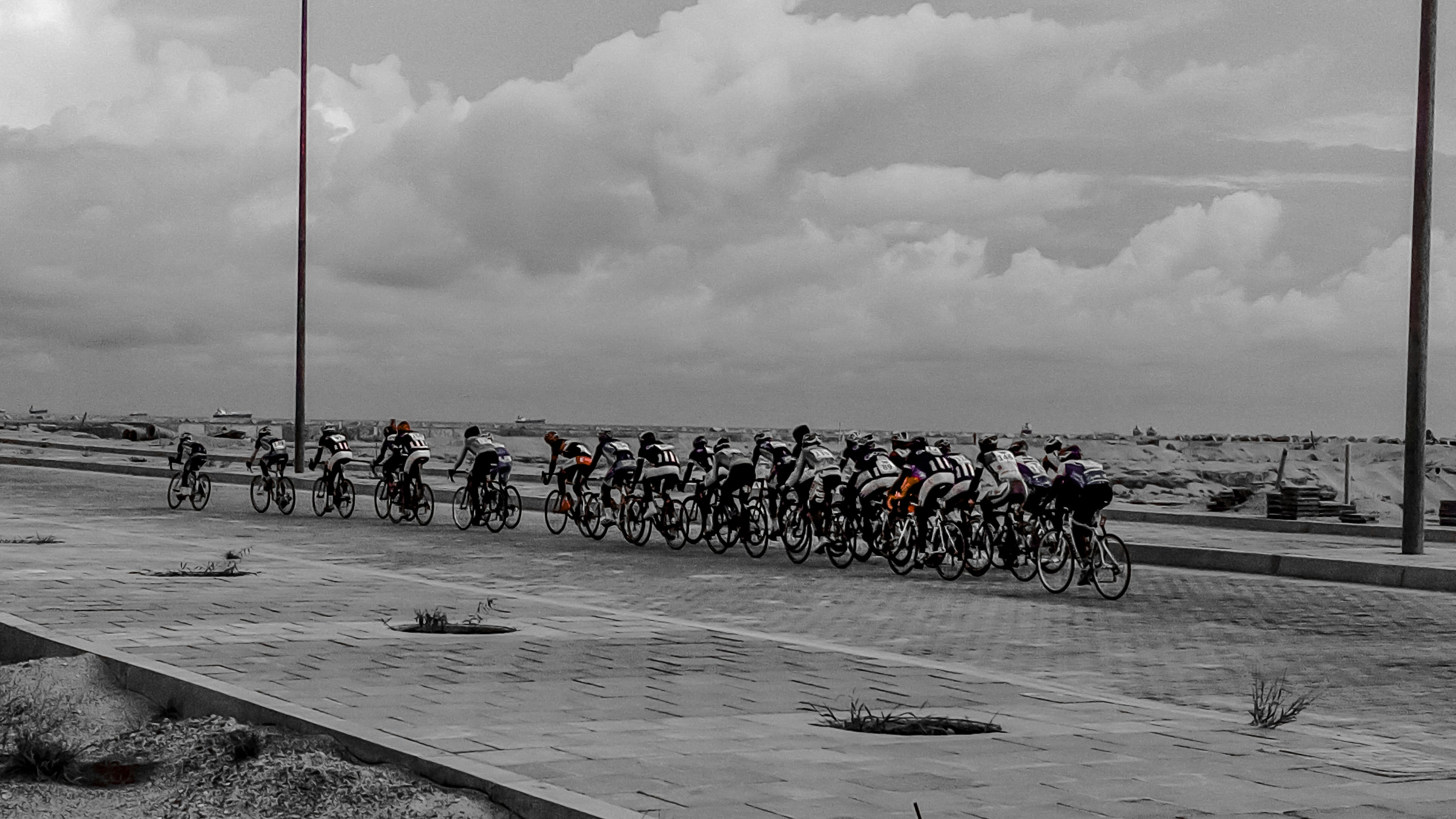 Peloton Surge Along Coastal Road