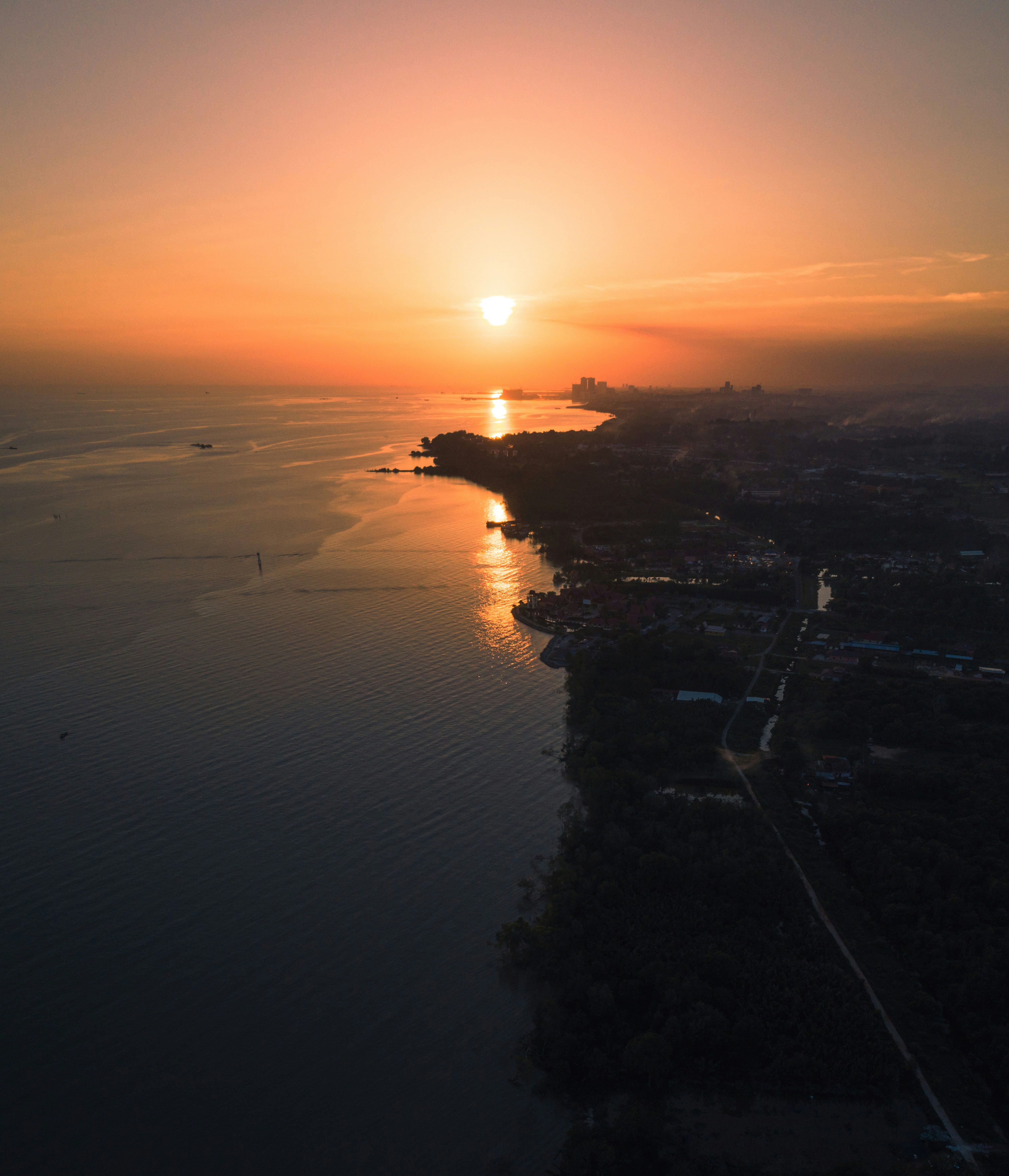 Silhouette of a person standing on a beach during sunset photo – Free ...