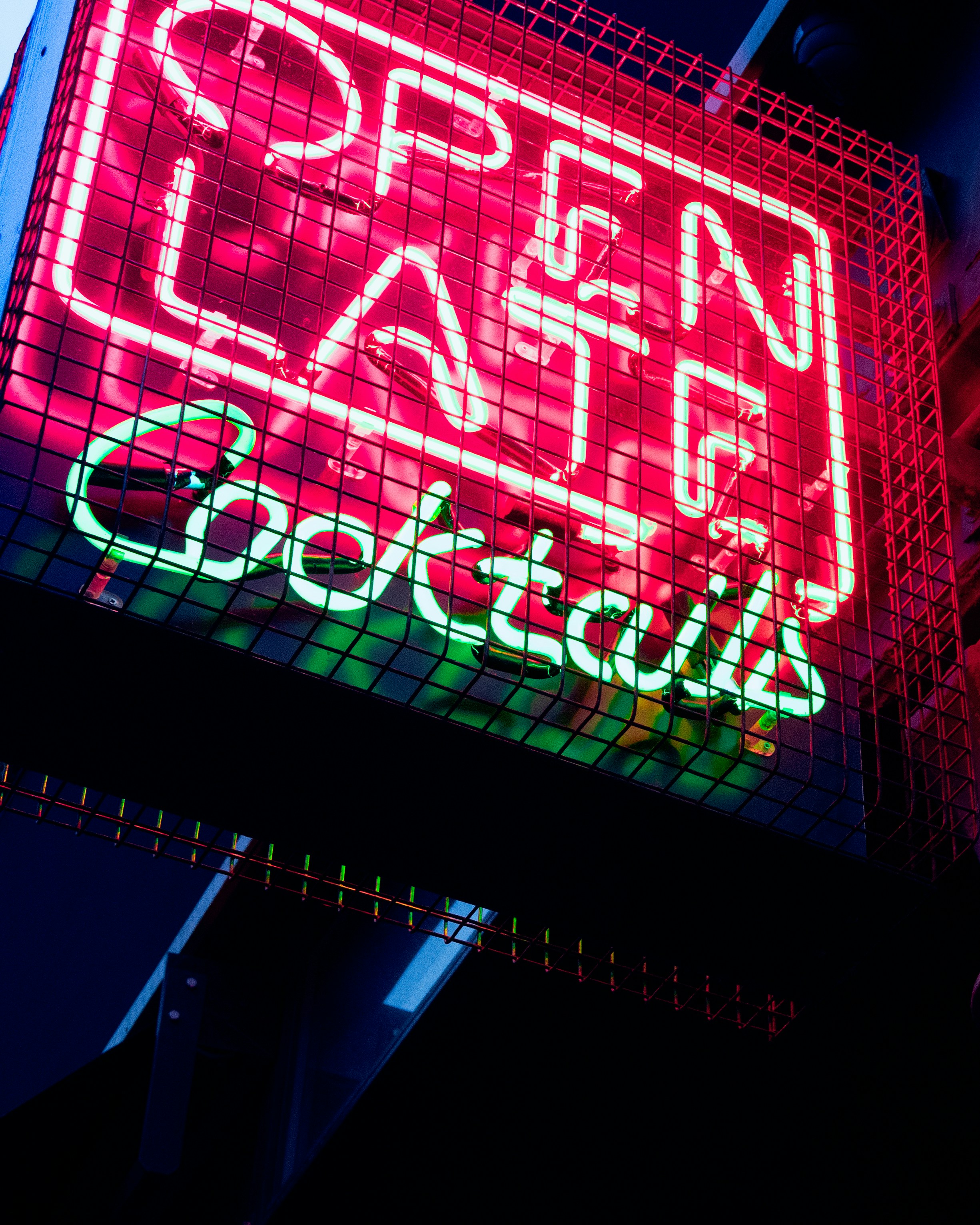 Neon Overhang: Red-Coded Signage Above the Dark Night