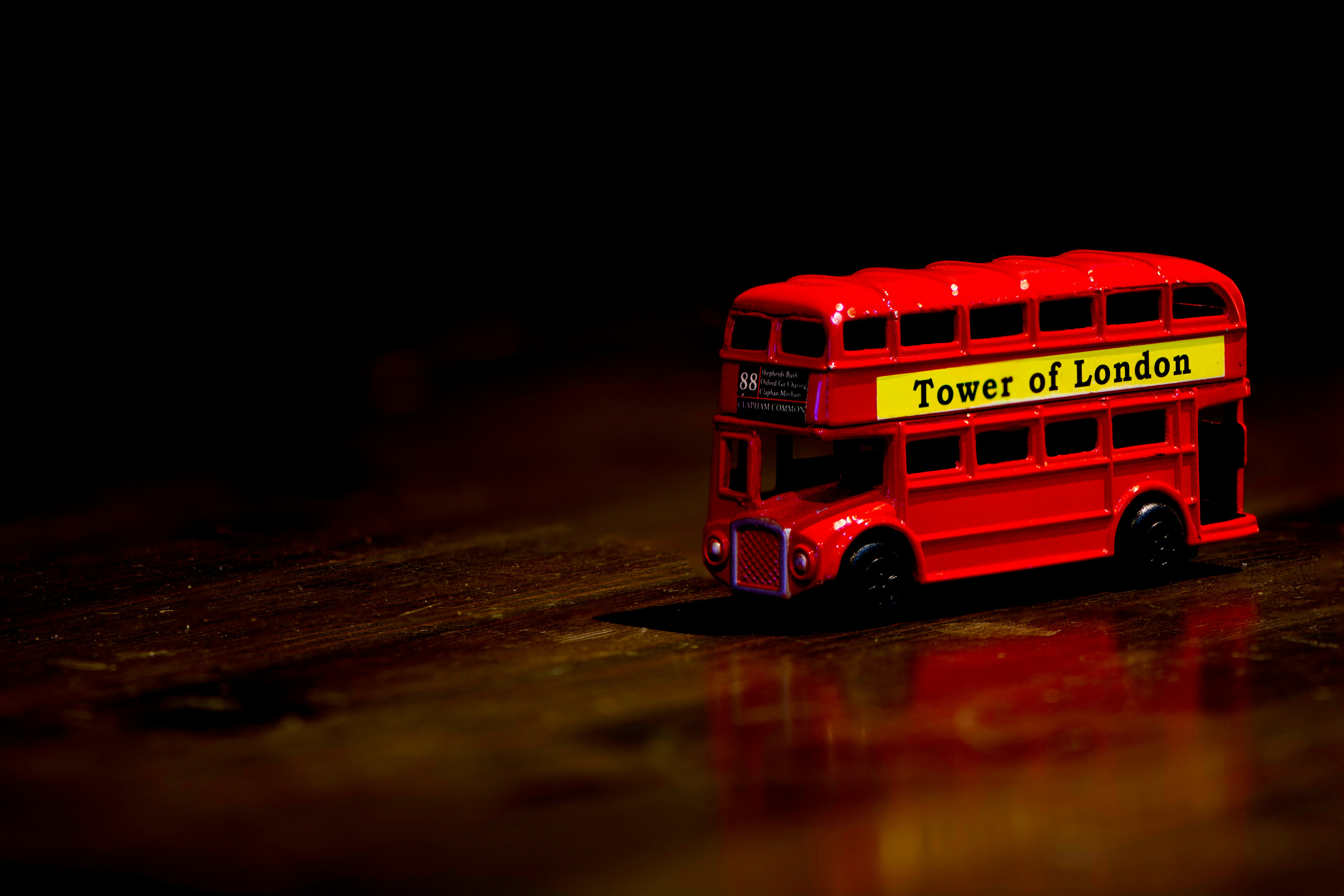 Red London Bus Under a Velvet Spotlight