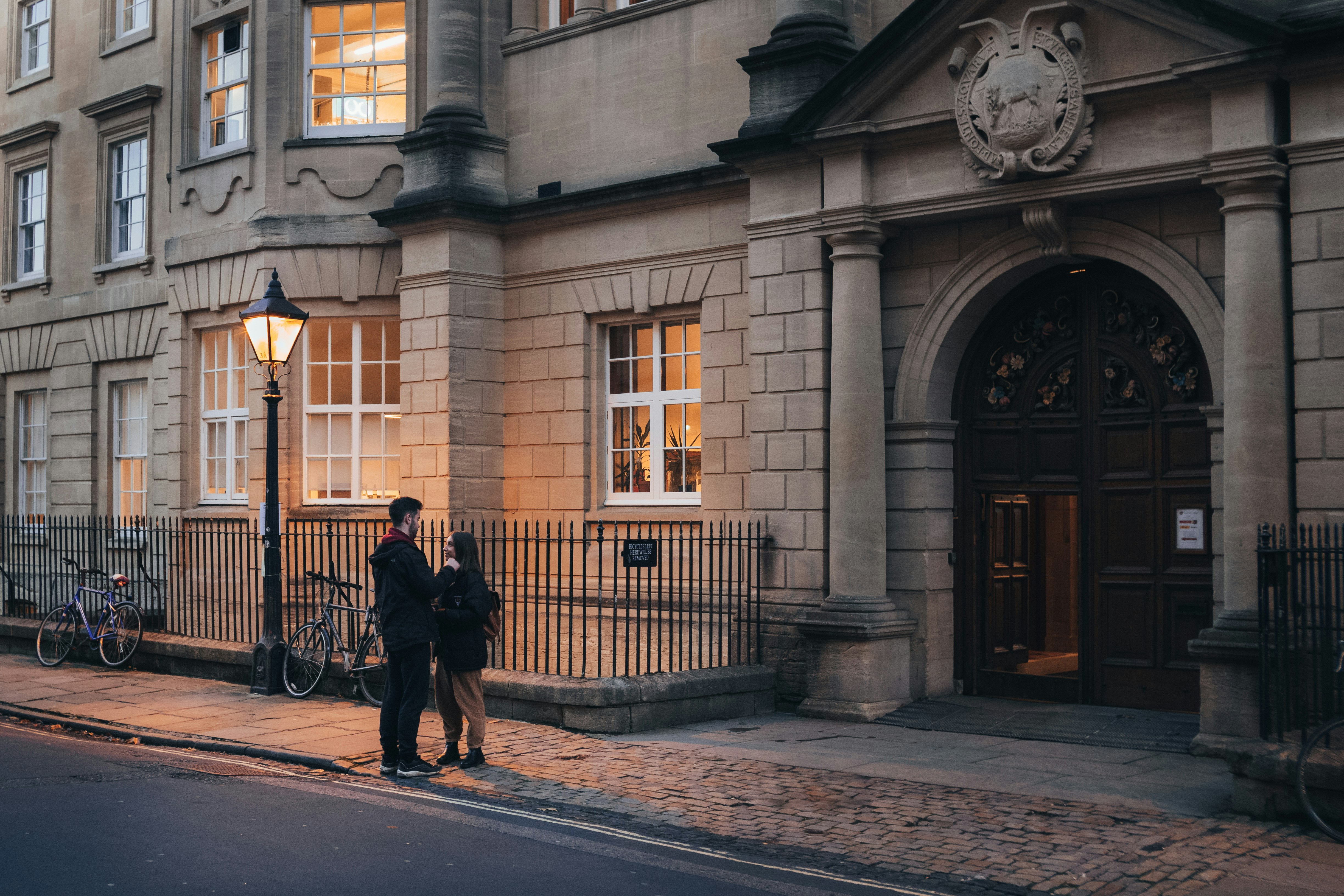 2 person walking on sidewalk near building during daytime photo – Free ...
