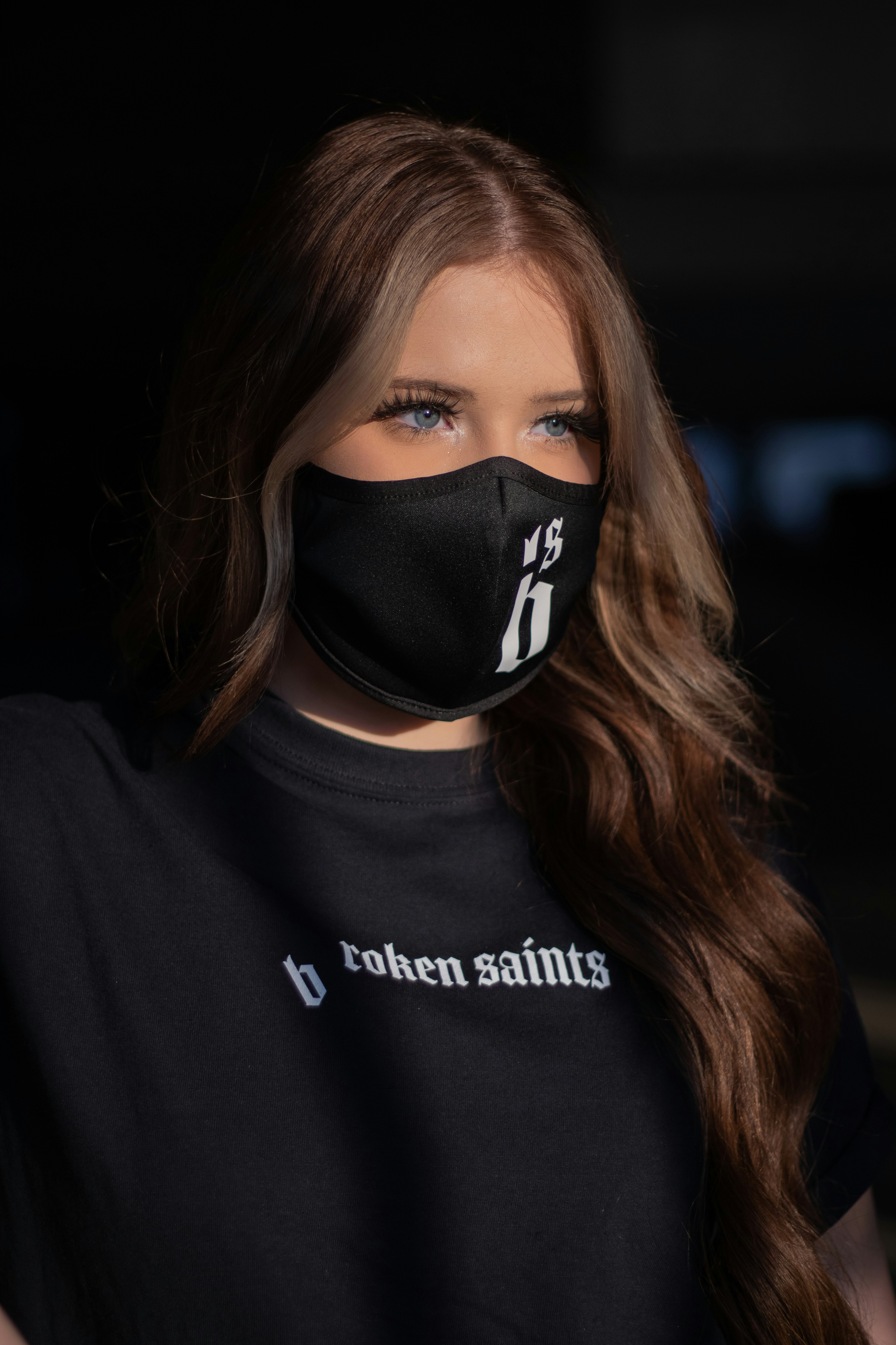 Woman in black and white crew neck shirt wearing black mask photo ...