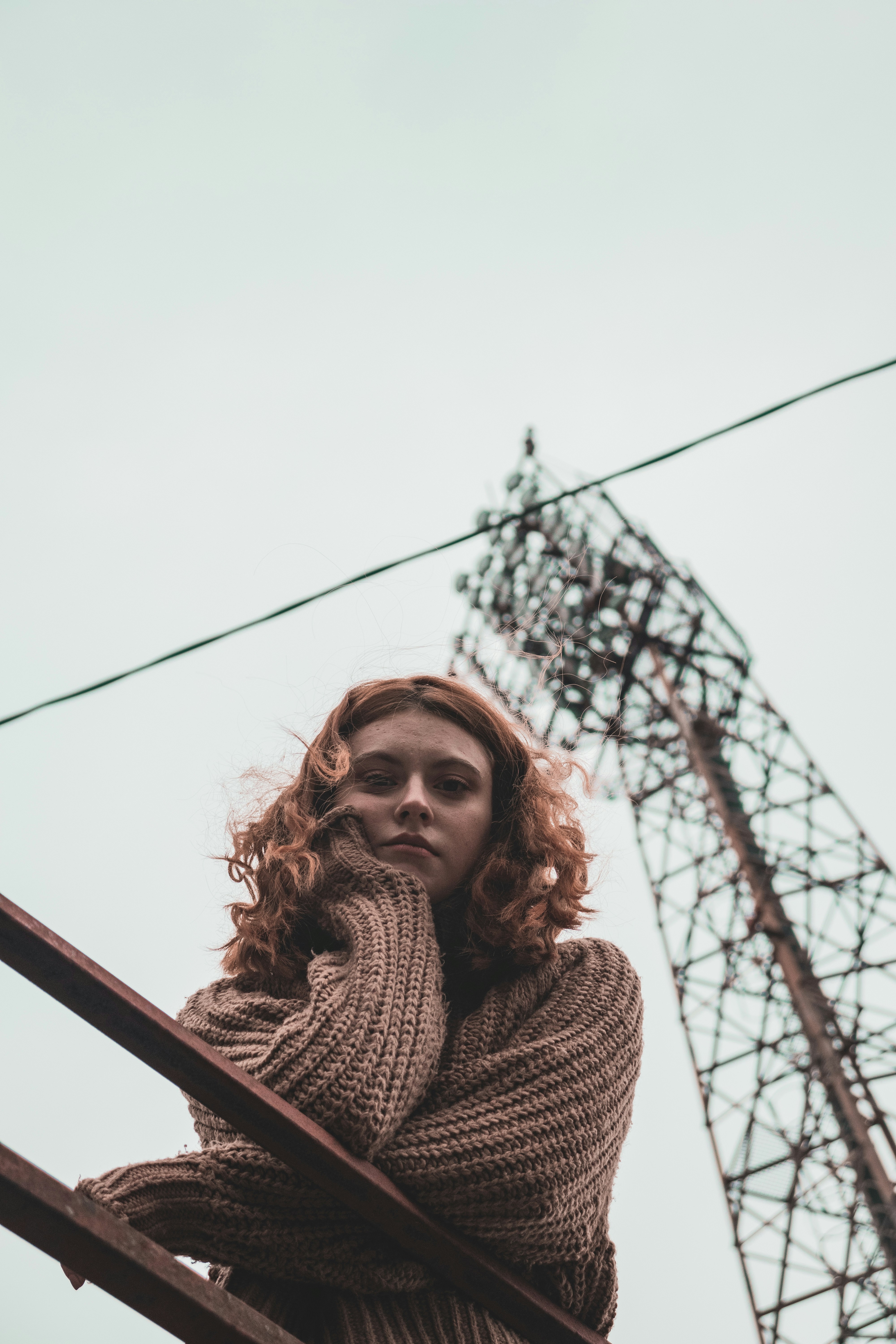 Crimson curls under a steel skyline: a low-angle portrait