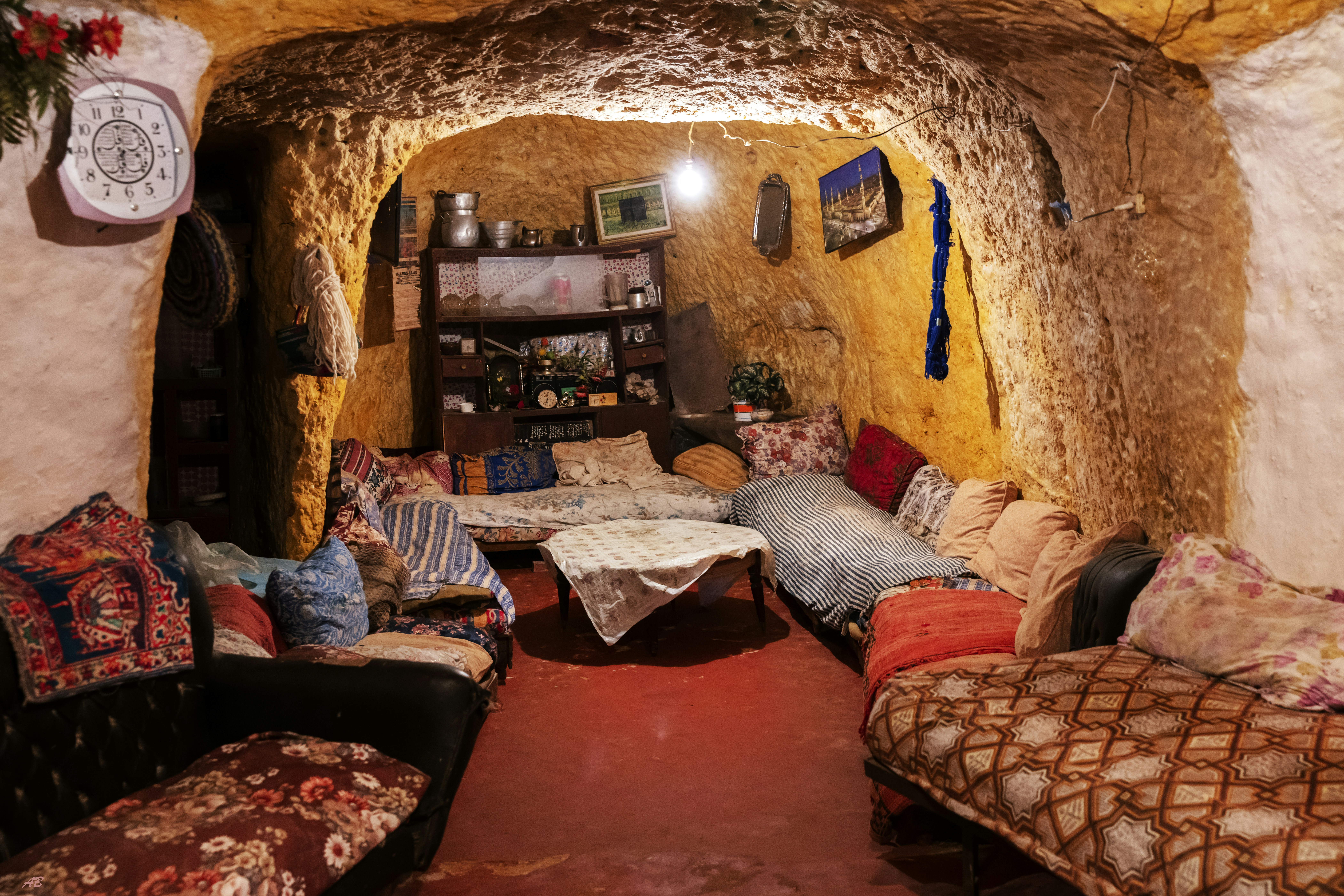 Cavern Living Room: Cushioned Comfort in a Stone-arched Shelter