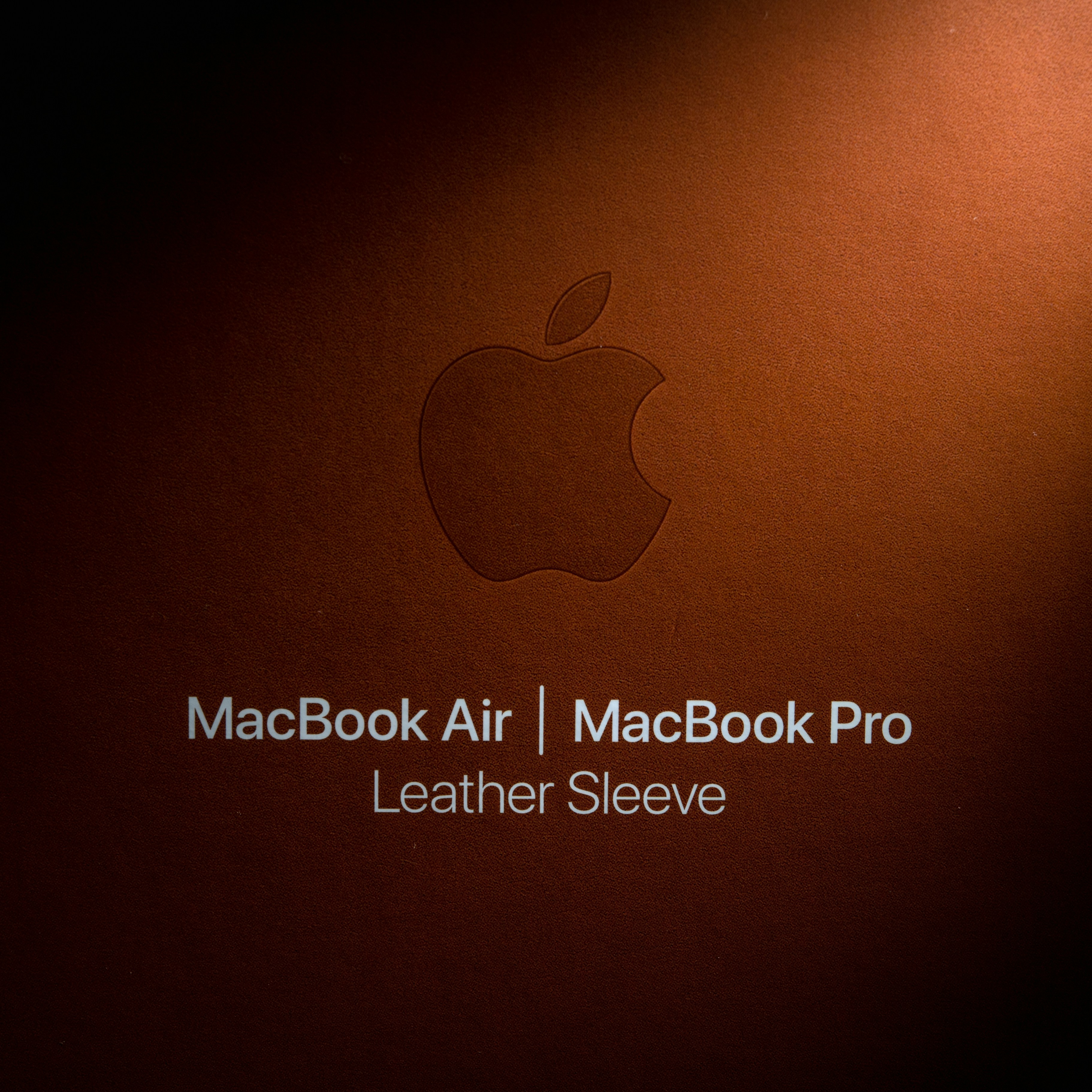 Apple Emblem on Cocoa Leather MacBook Sleeve in Gentle Glow