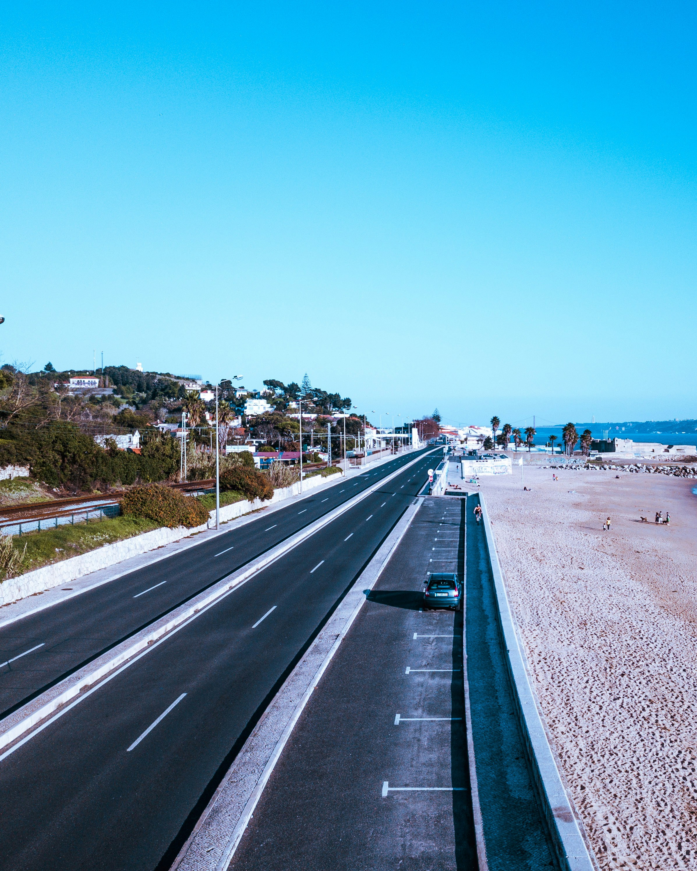 Horizon Road: A Sunlit Coastal Boulevard Framing Sea and Sand