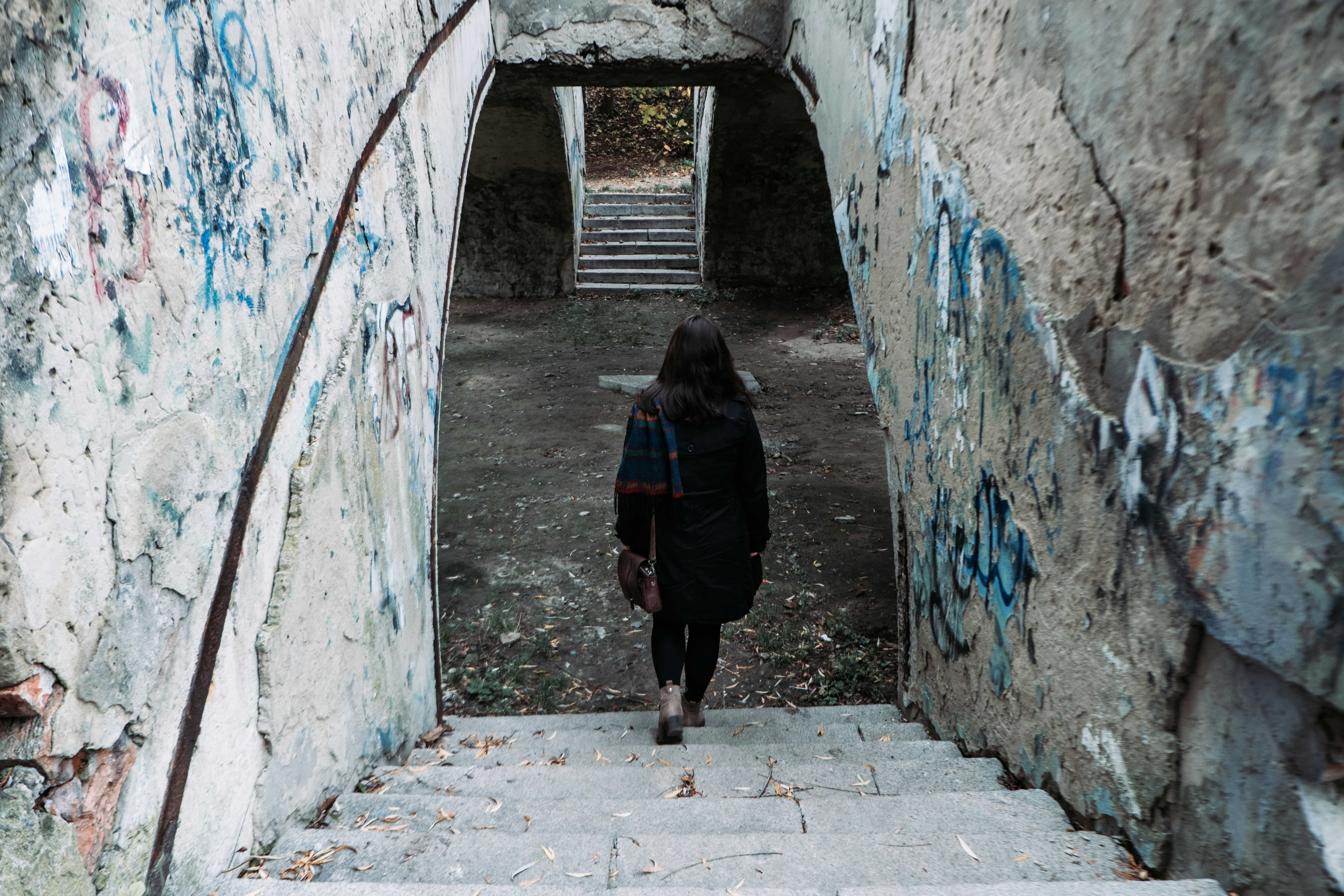 Echoes at the Graffiti Stairwell: a lone traveler descends toward daylight