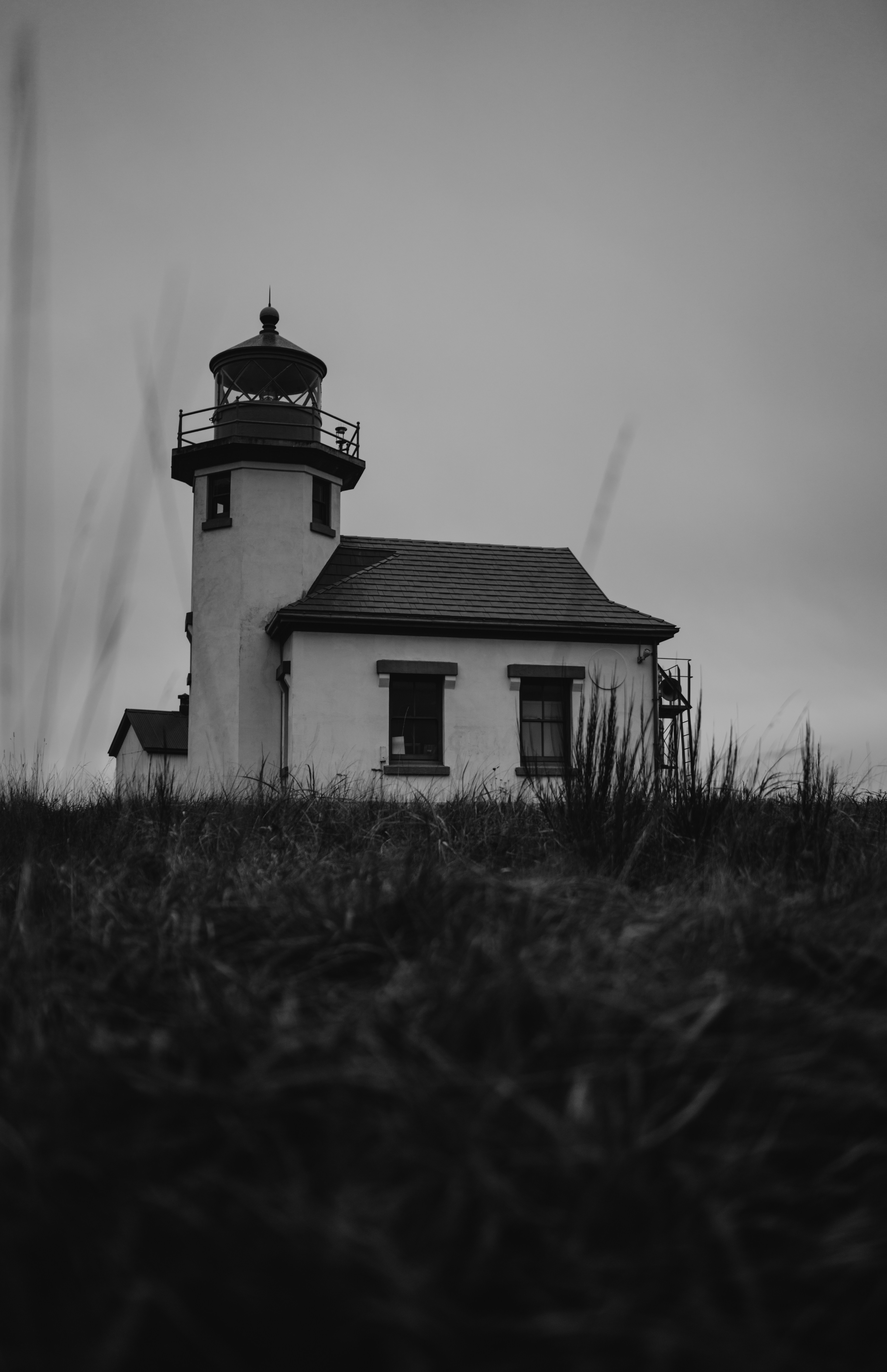 Grayscale photo of lighthouse near grass field photo – Free Travel ...