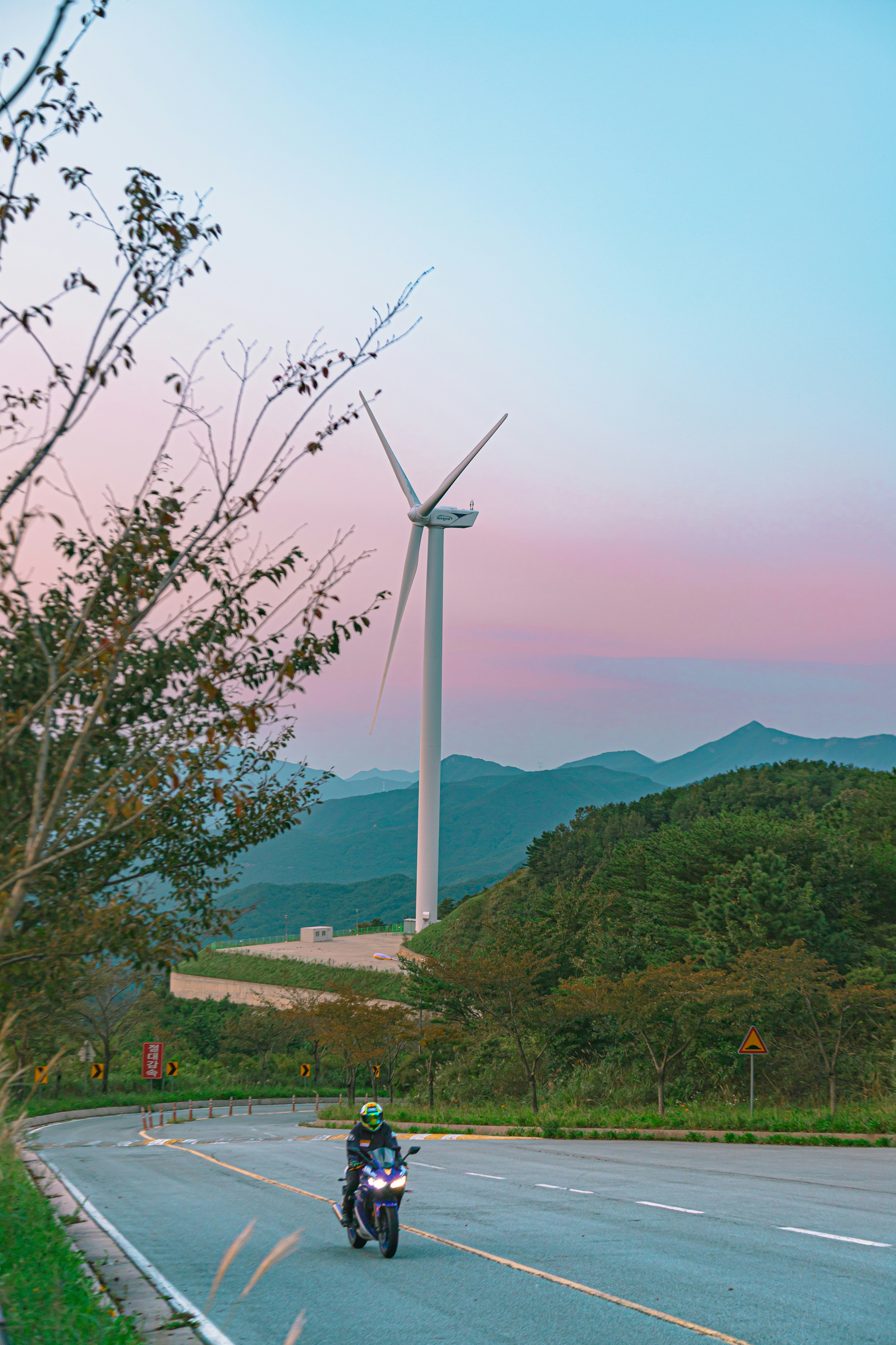 Twilight Turn: Wind Turbine and a Rider on the Quiet Horizon