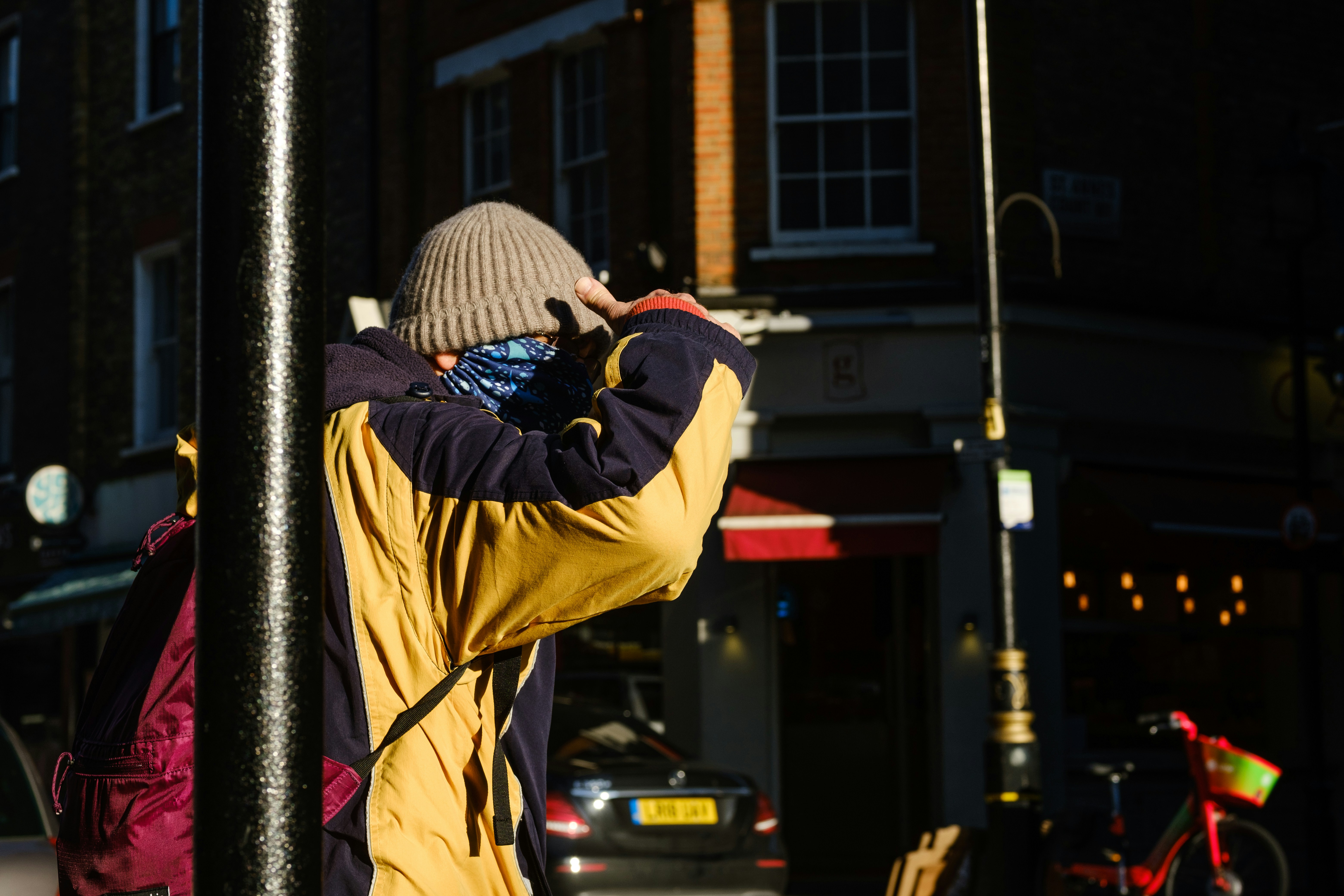 Man in yellow jacket covering face with his hand photo – Free Wardour ...