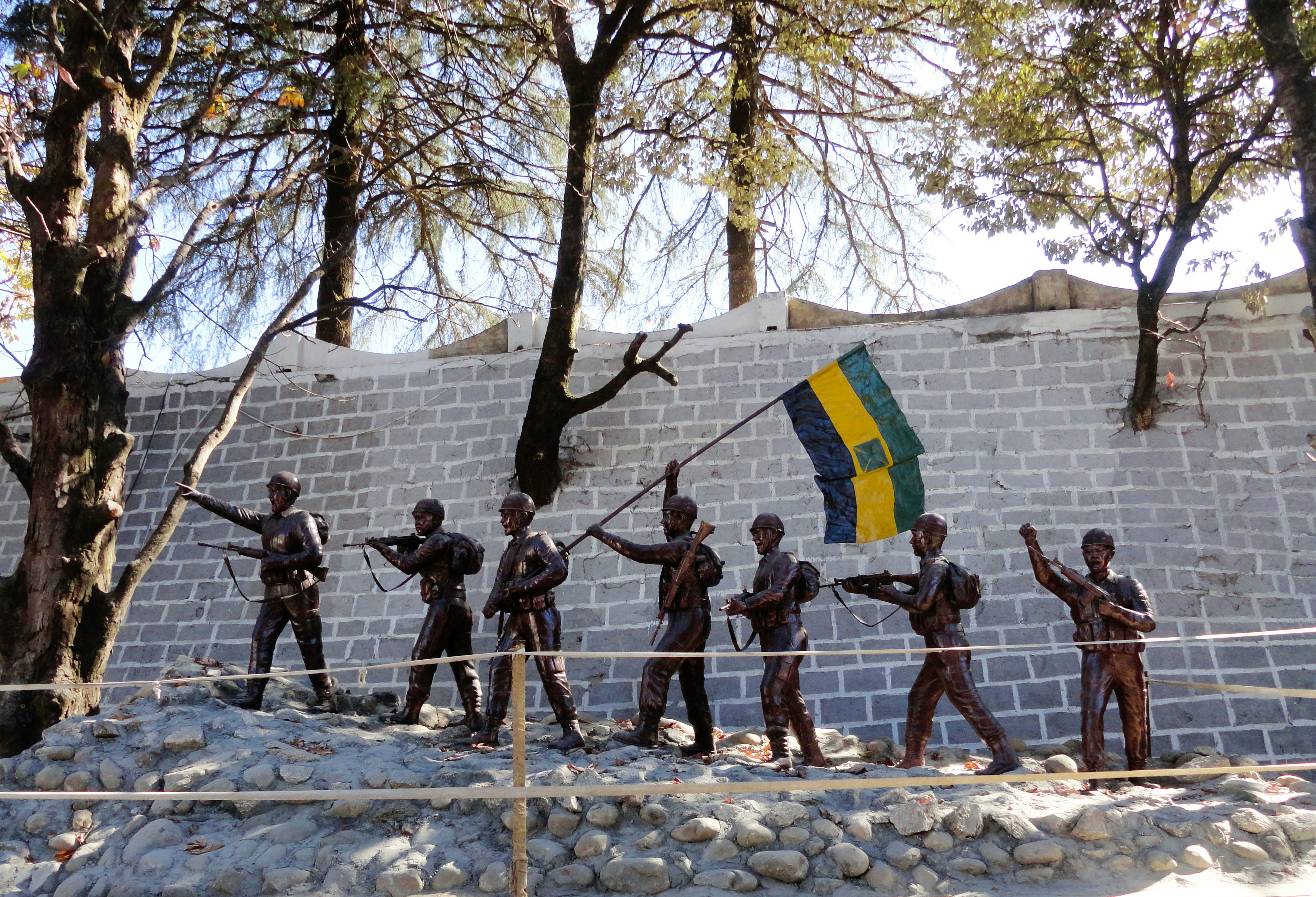 Ice hockey players in action on a snow-covered field during the day.
