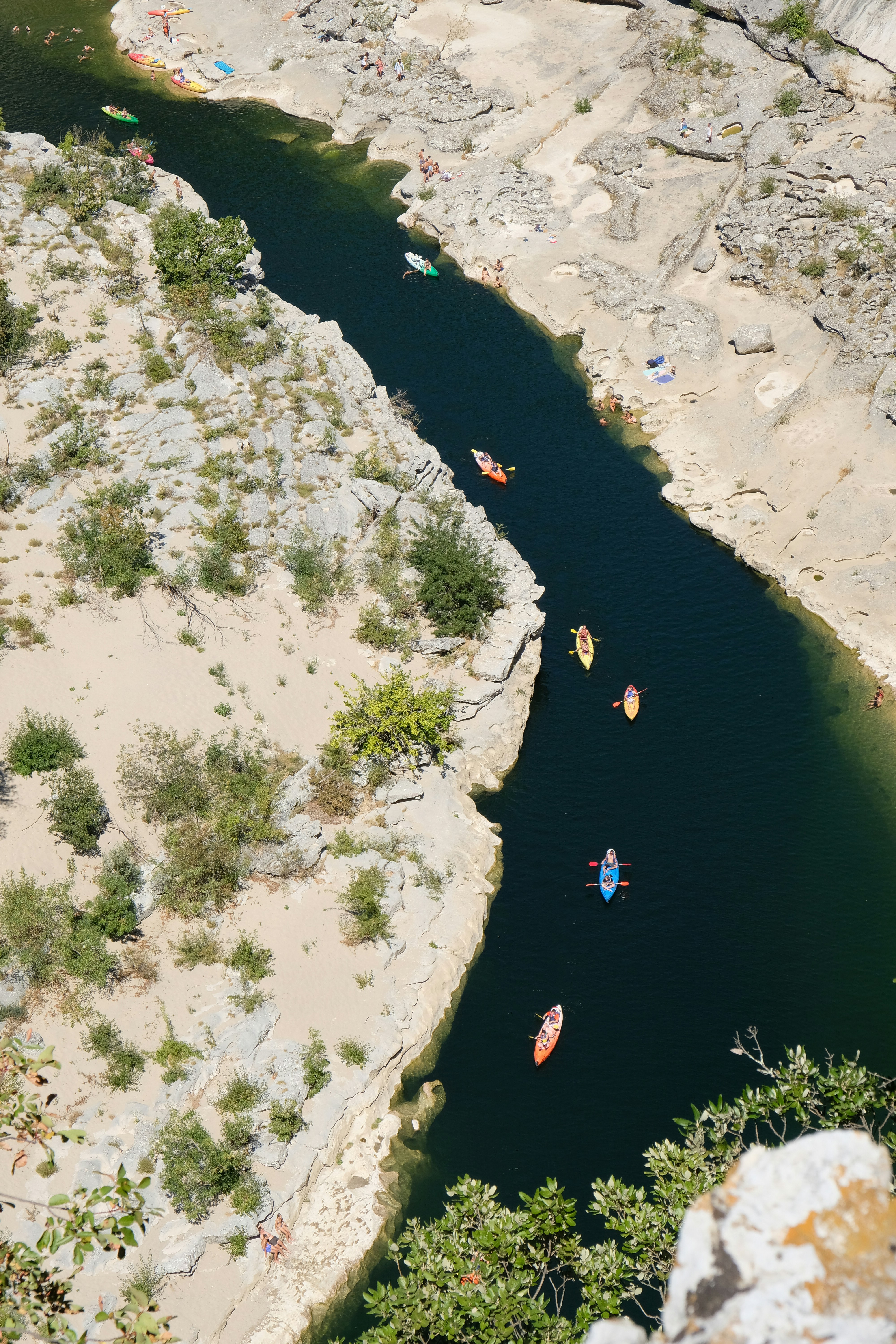 Sunlit Gorge Kayaks: A Ribbon of Color Through a Quiet Canyon