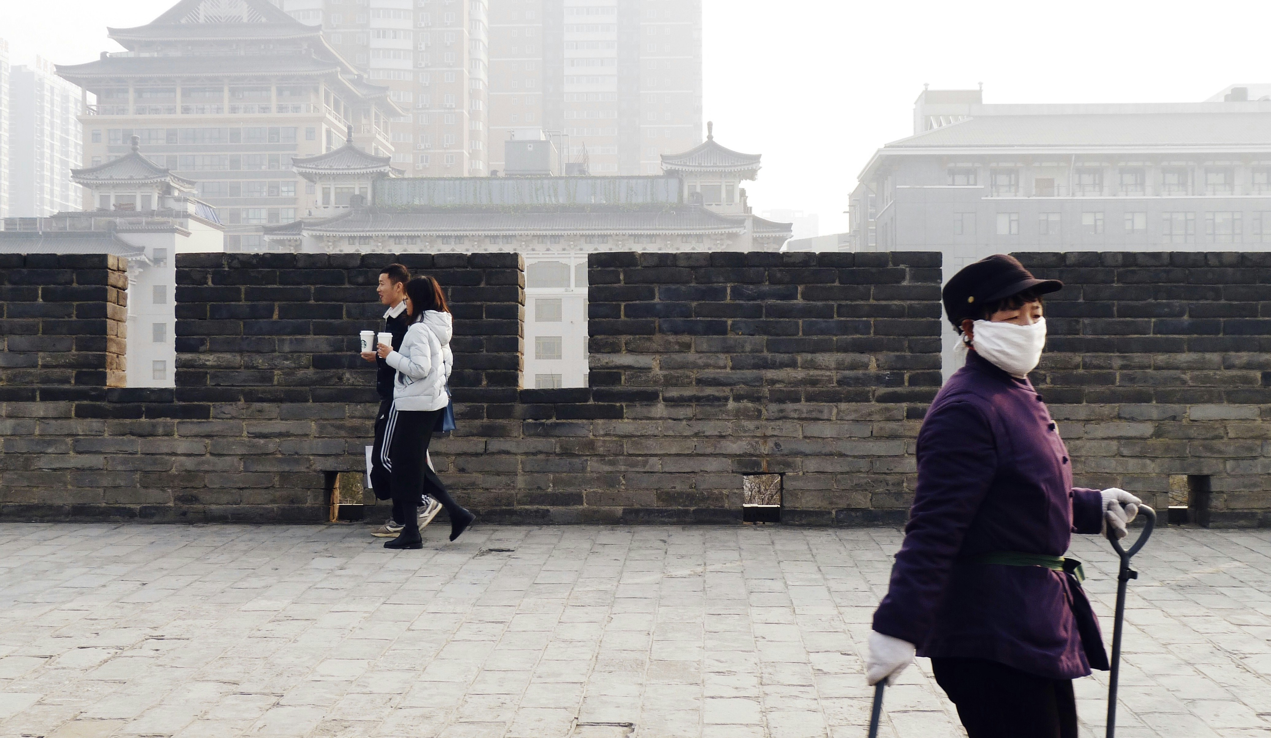 Masked Pedestrian in a Quiet City Terrace