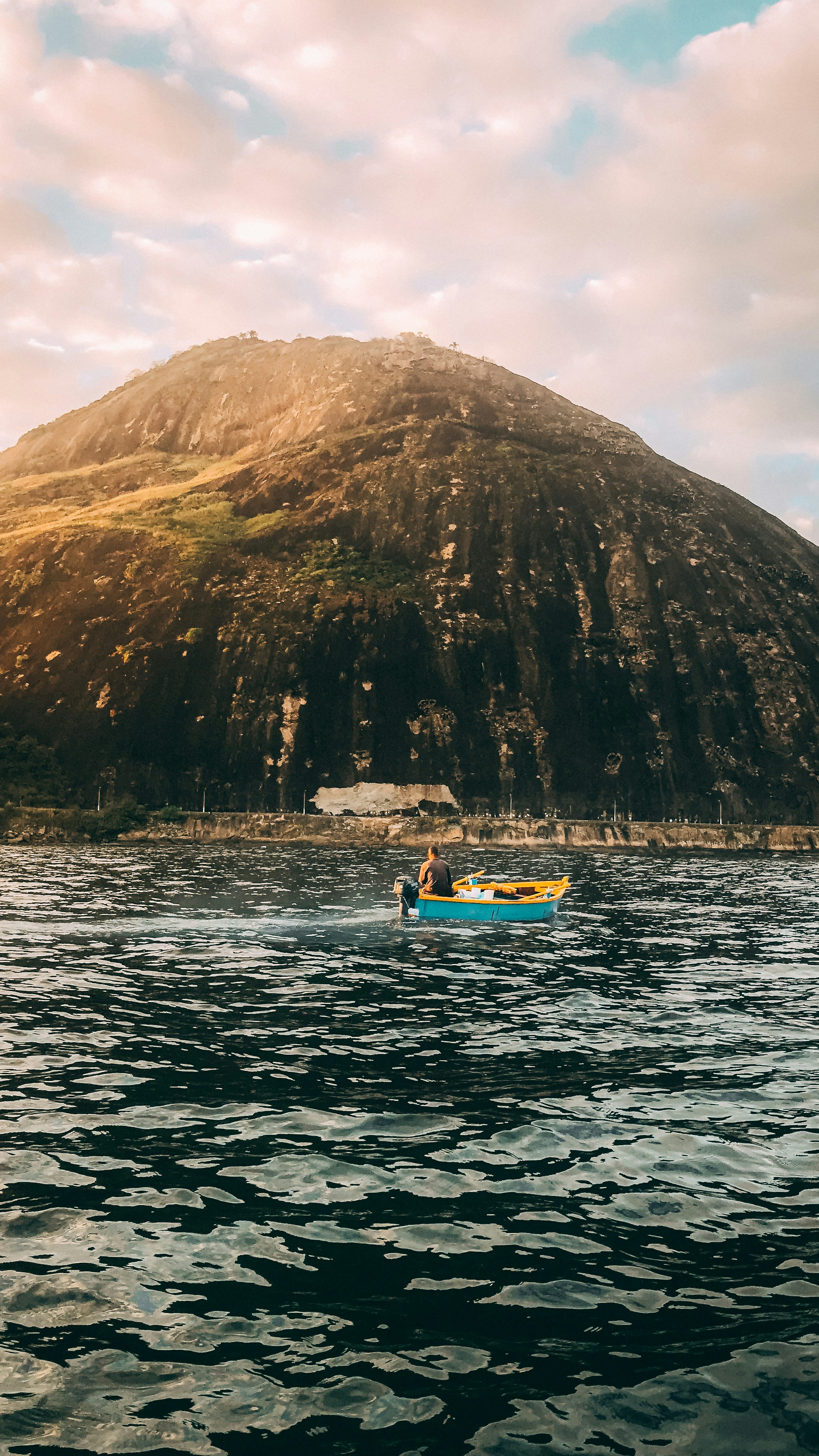 Little Boat, Grand Cliff: A Quiet Seascape at Dusk