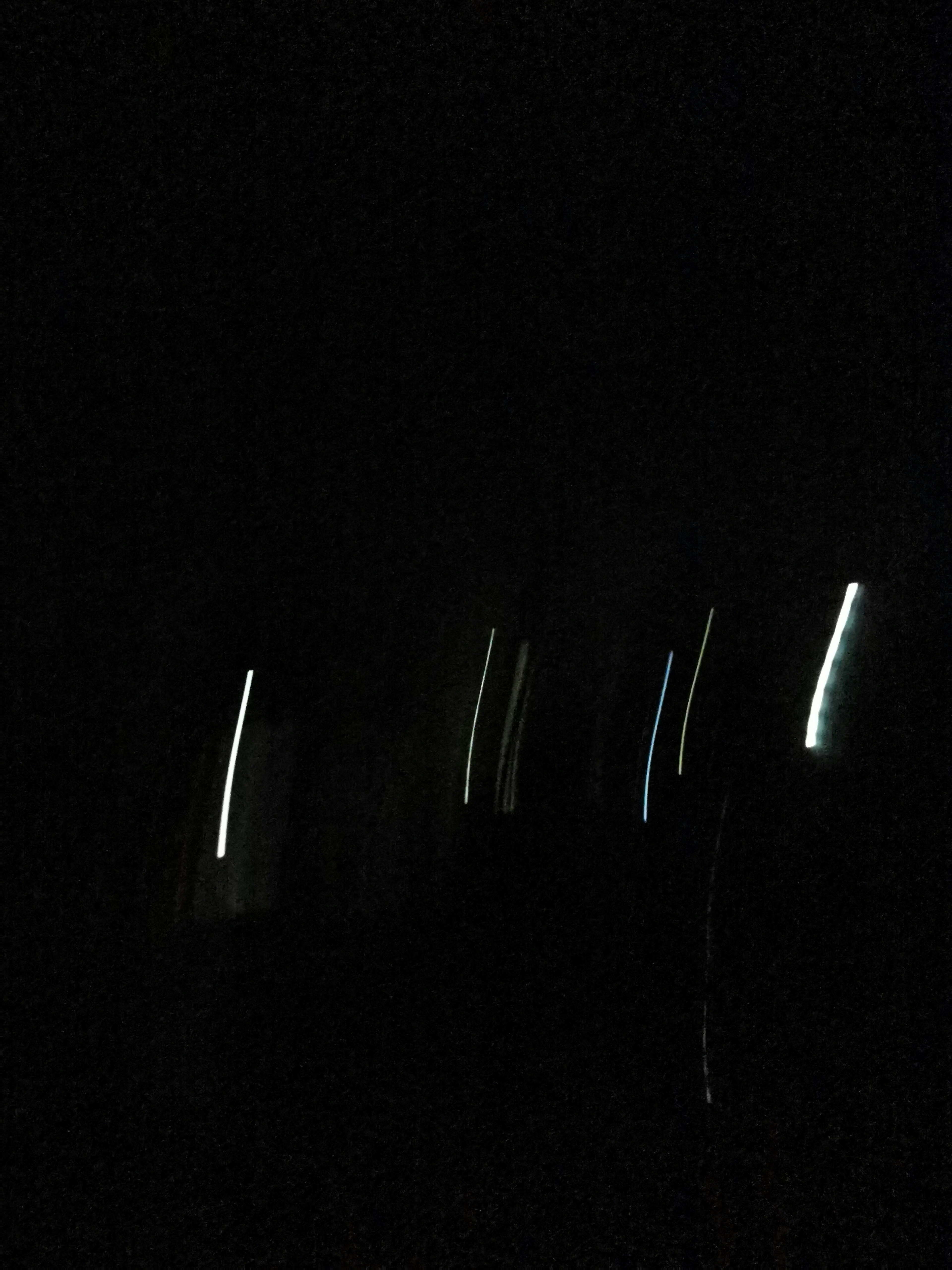 Abstract representation of light streaks captured in low light conditions, creating a dynamic interplay of illumination and shadow.