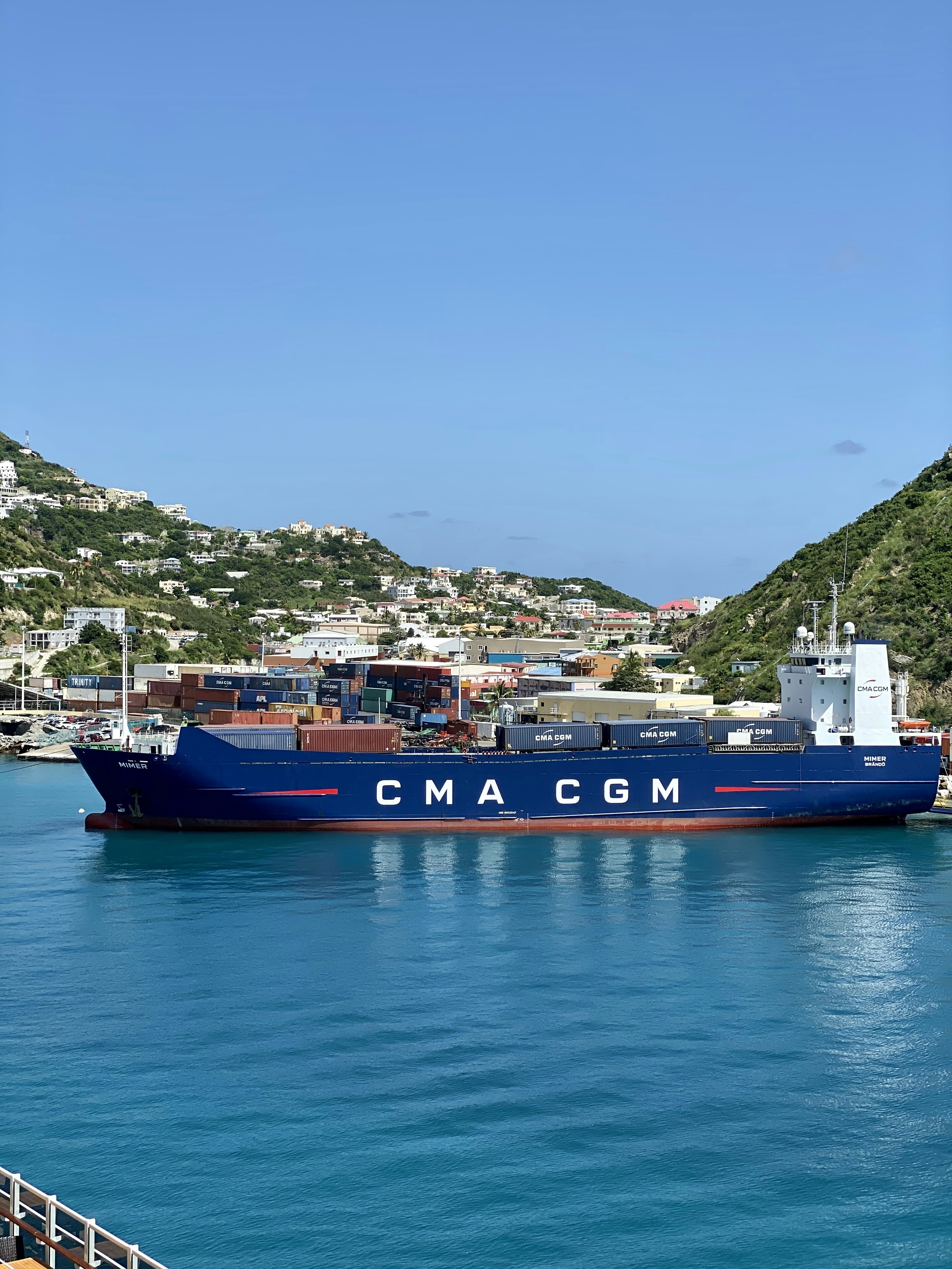 Blue Behemoth Anchored in a Hillside Harbor
