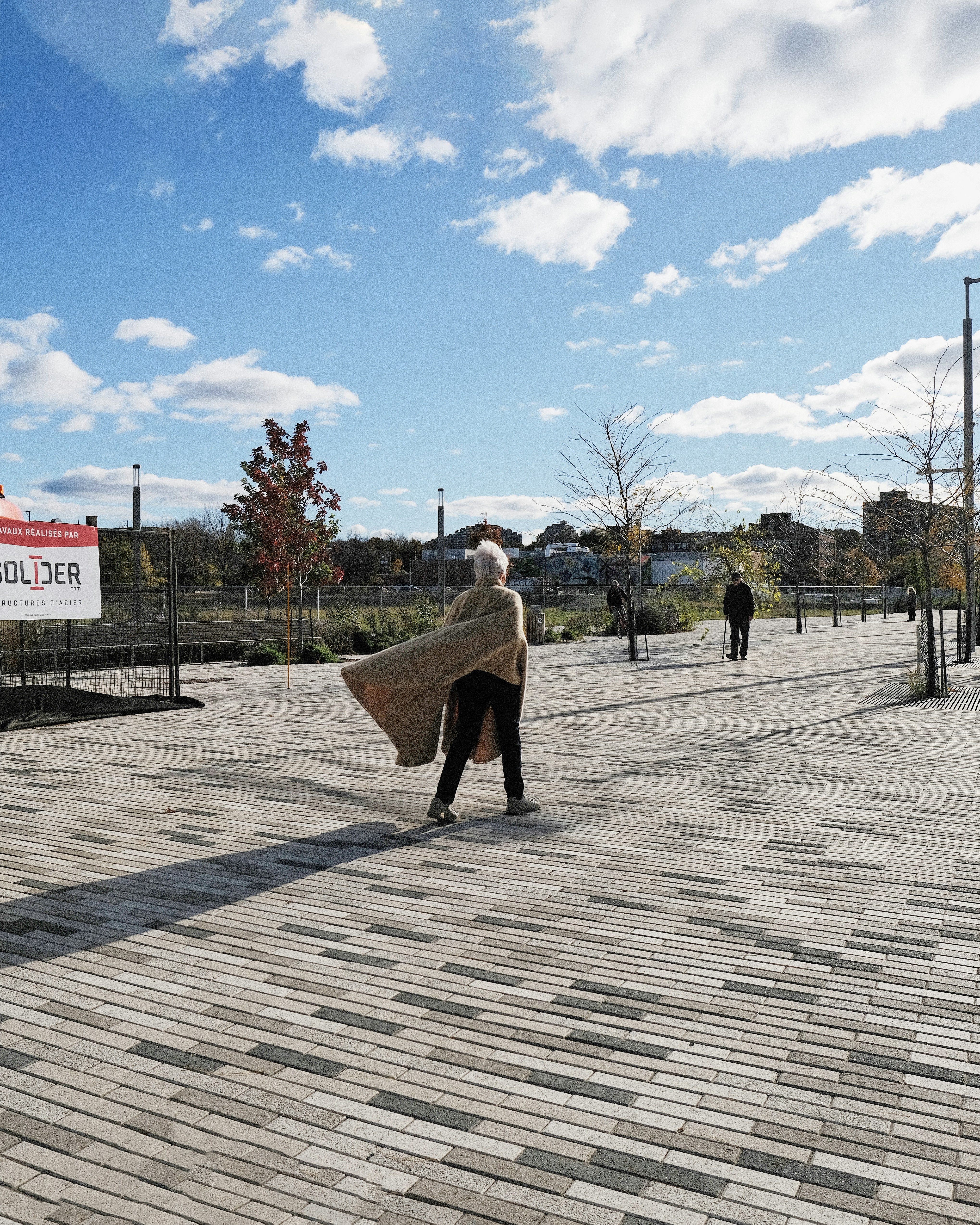 Cloaked Voyager on a Sunlit Riverside Boardwalk