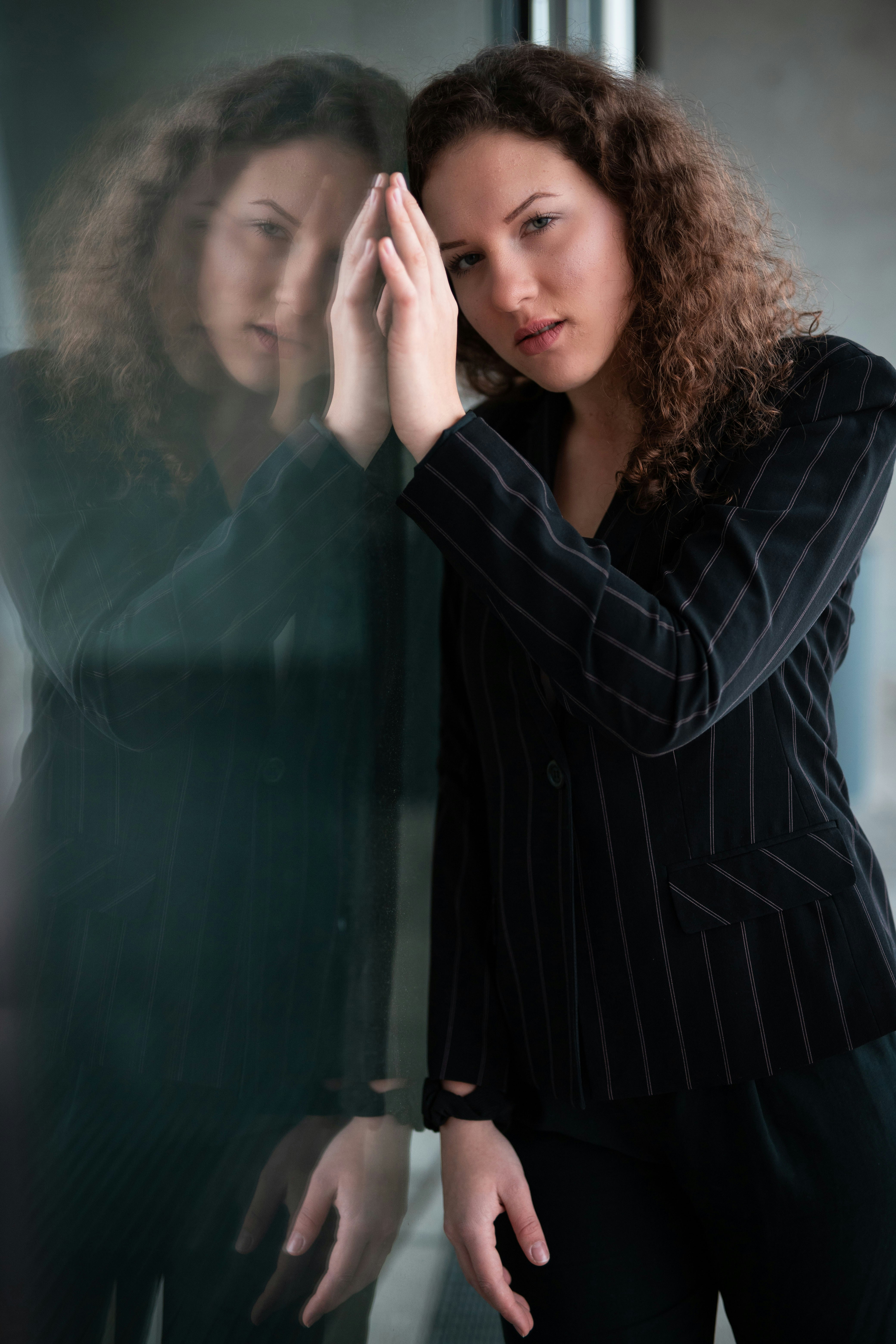 Glass and Gaze: A Pinstriped Portrait at the Window