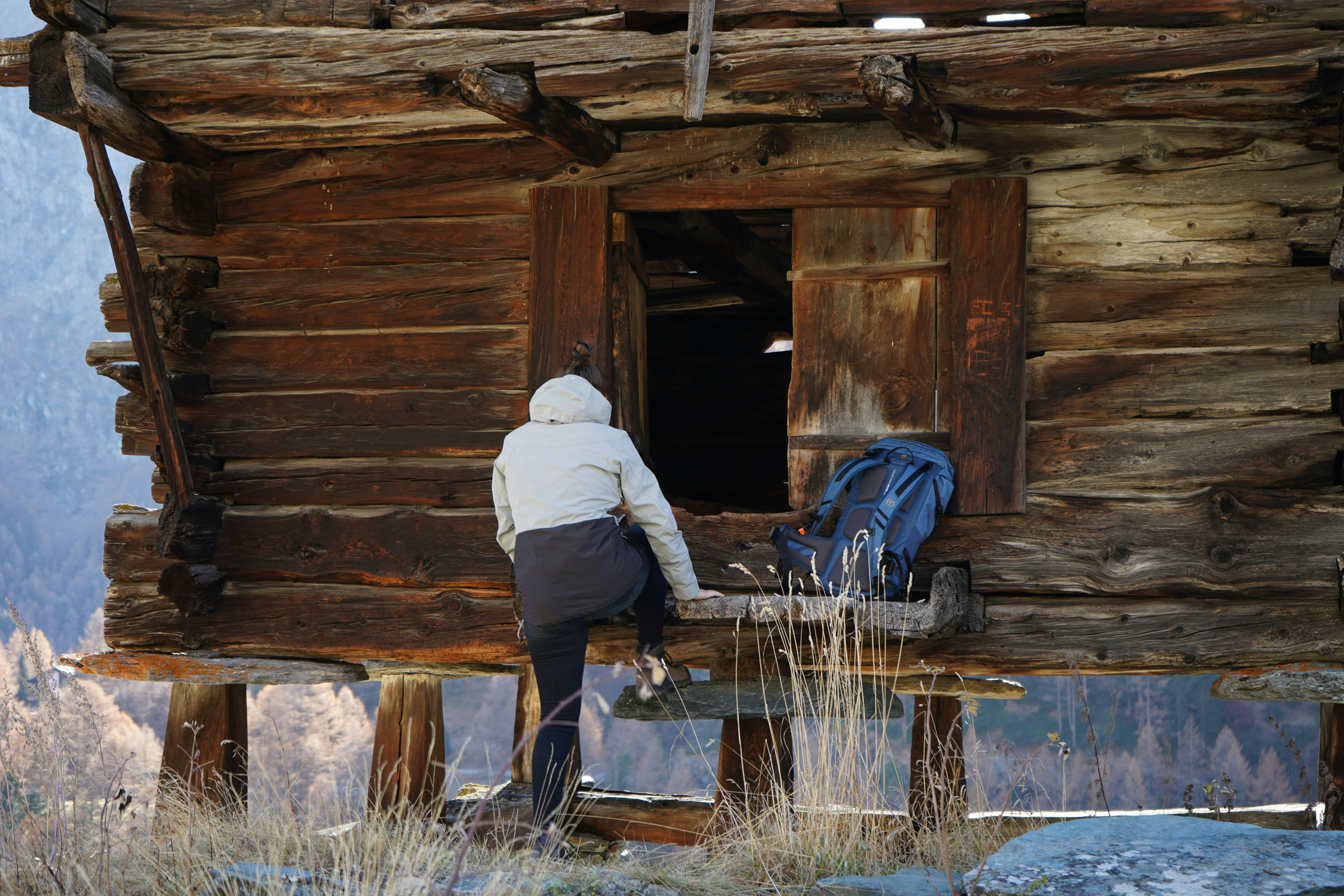 Old Cabin Ascent: A Climber Reaches for the Threshold