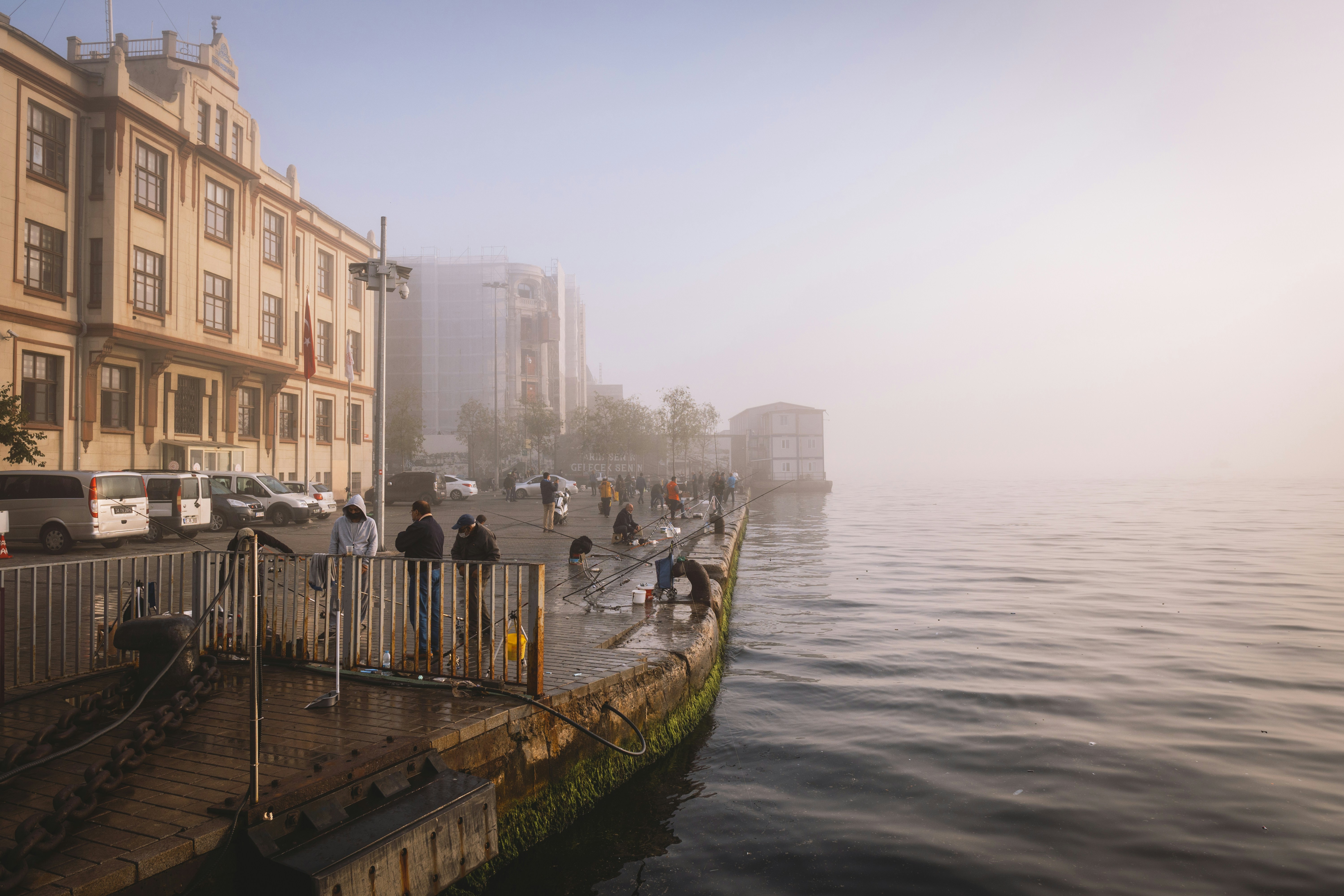 people on brown wooden dock near body of water during daytime