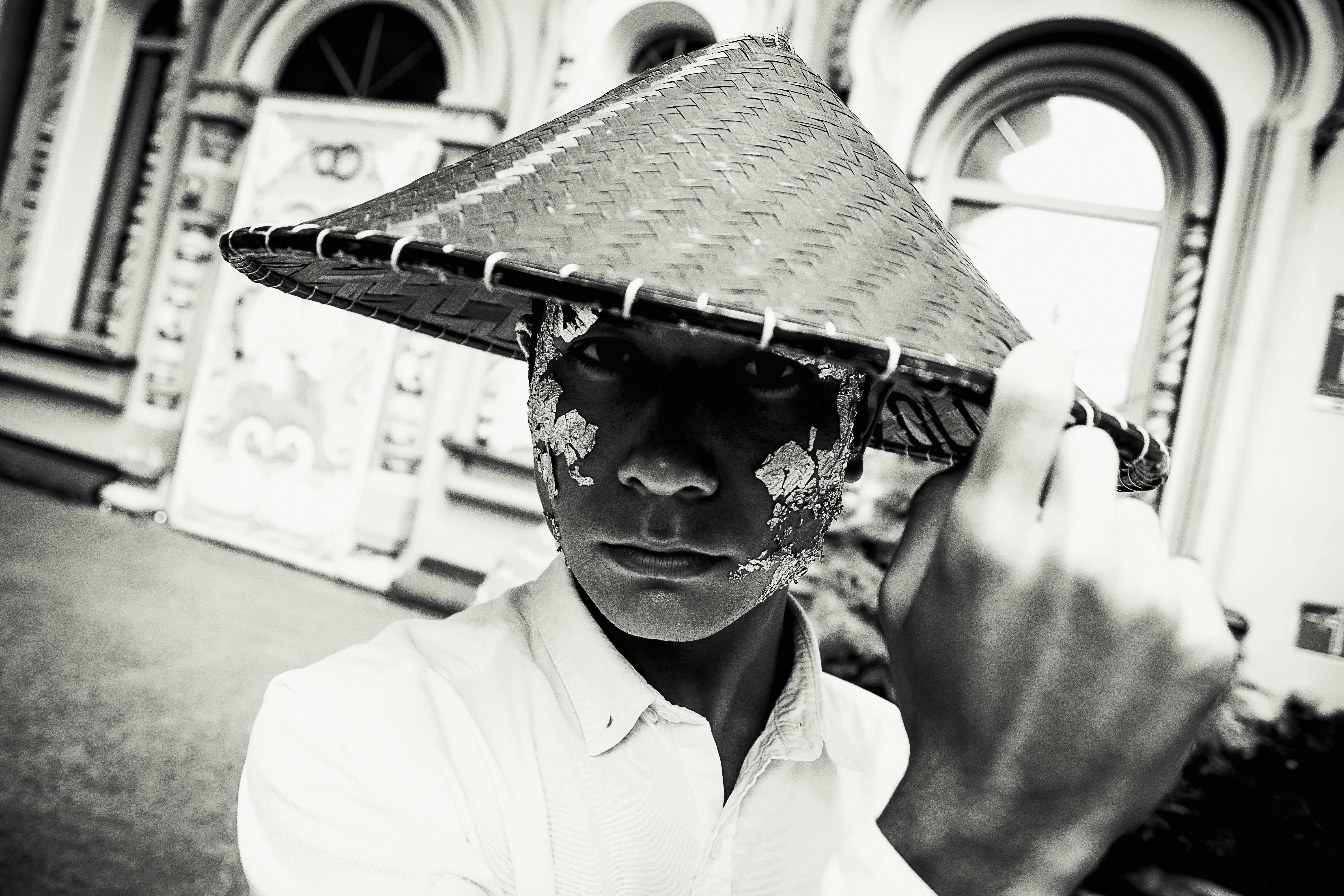 Shadowed Gaze Under a Straw Hat: A Street-Gray Monochrome Portrait